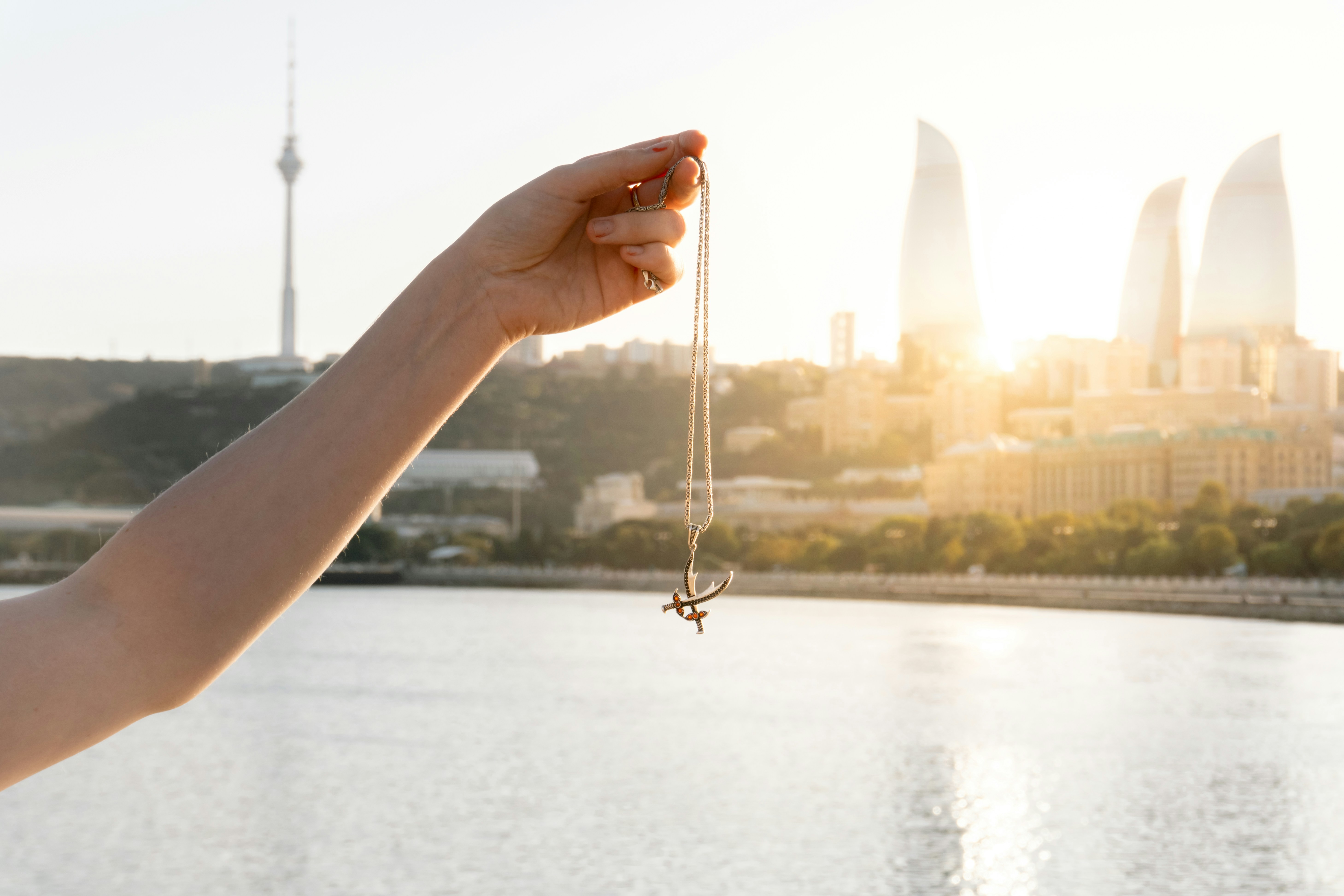 Anchor Pendant in Golden Hour Over a Distant Skyline