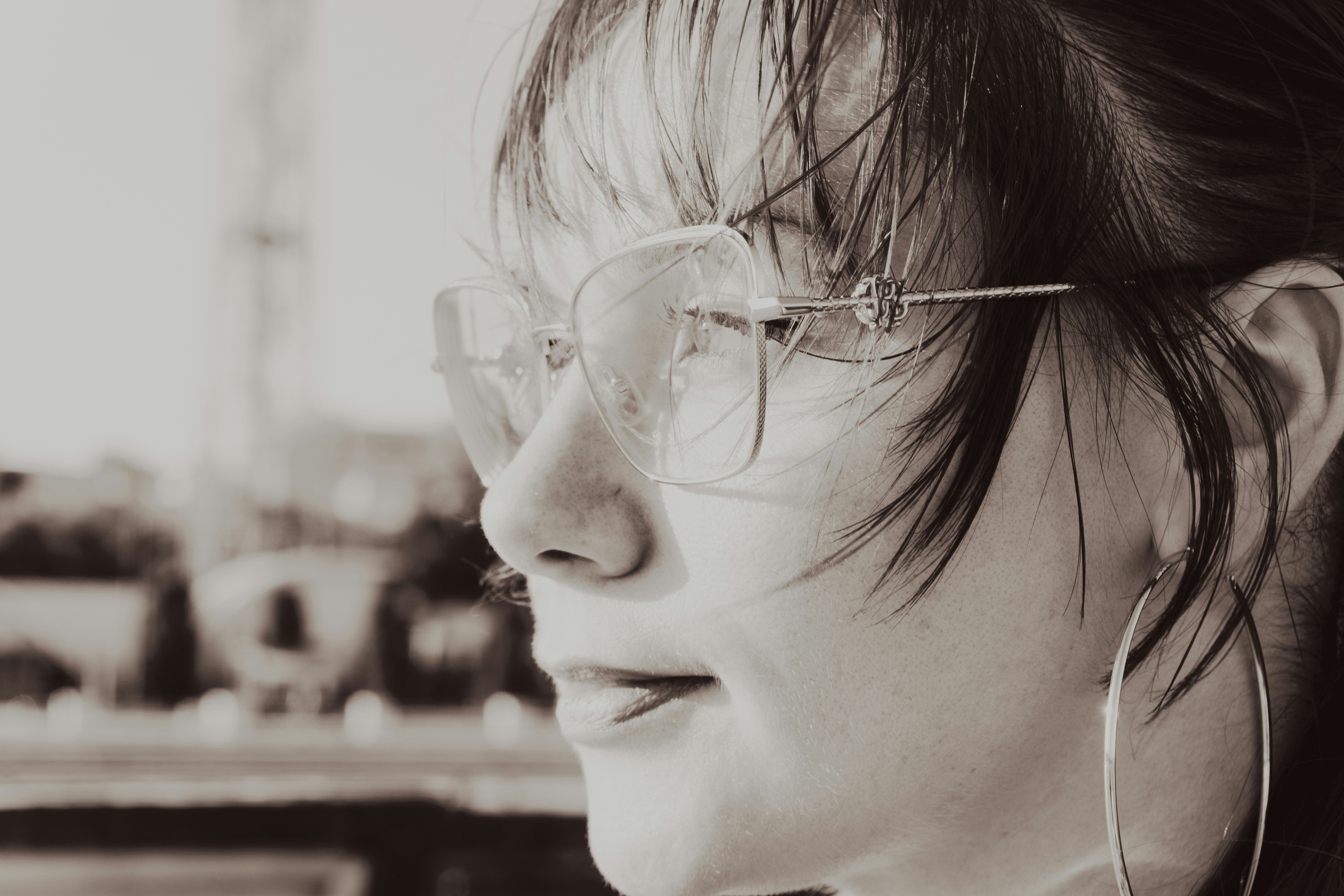 Glimmer of Focus: A Sepia Close-Up Portrait in Glasses