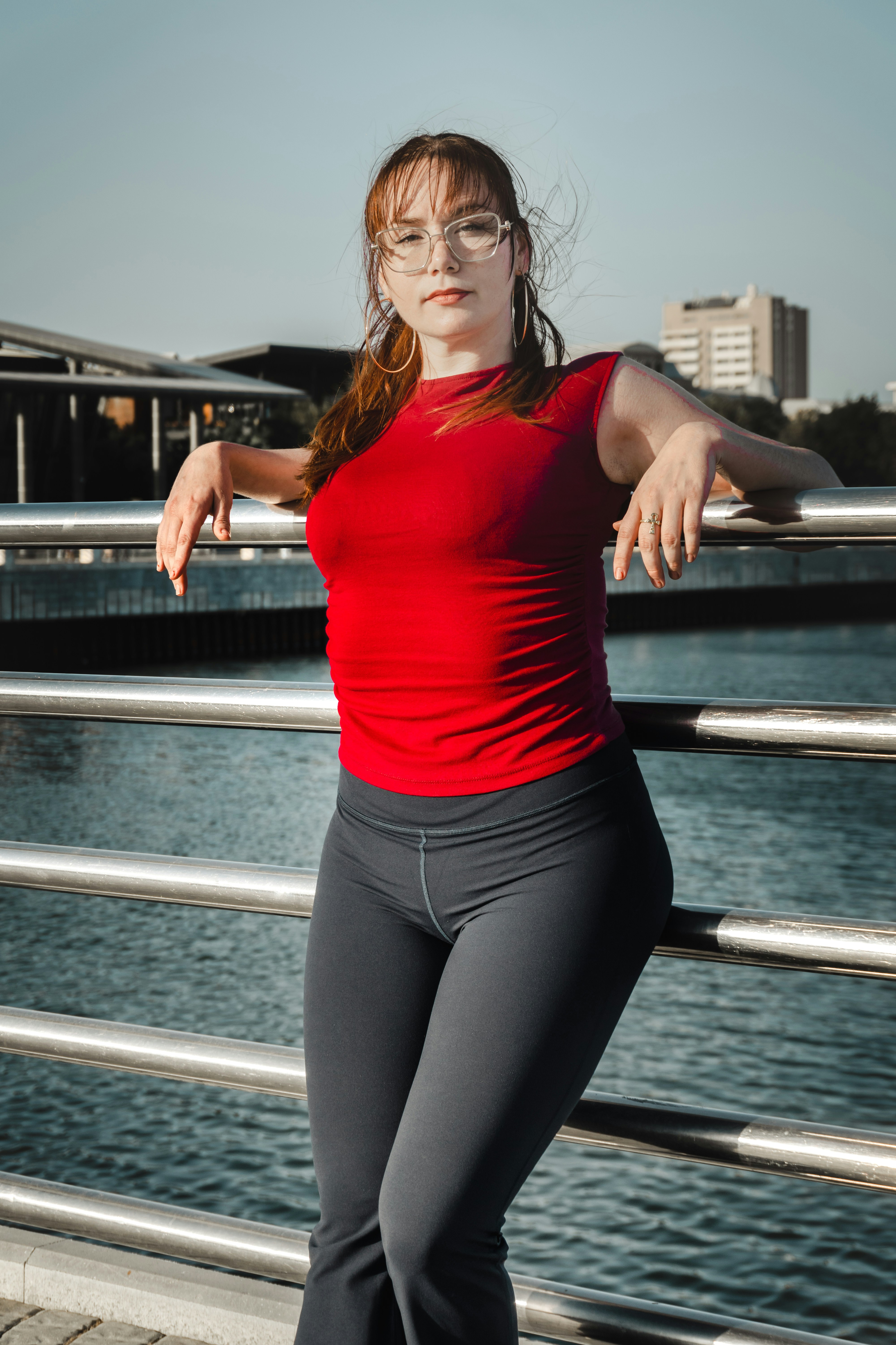 Crimson Top by the Riverfront: A Portrait on the City Pier