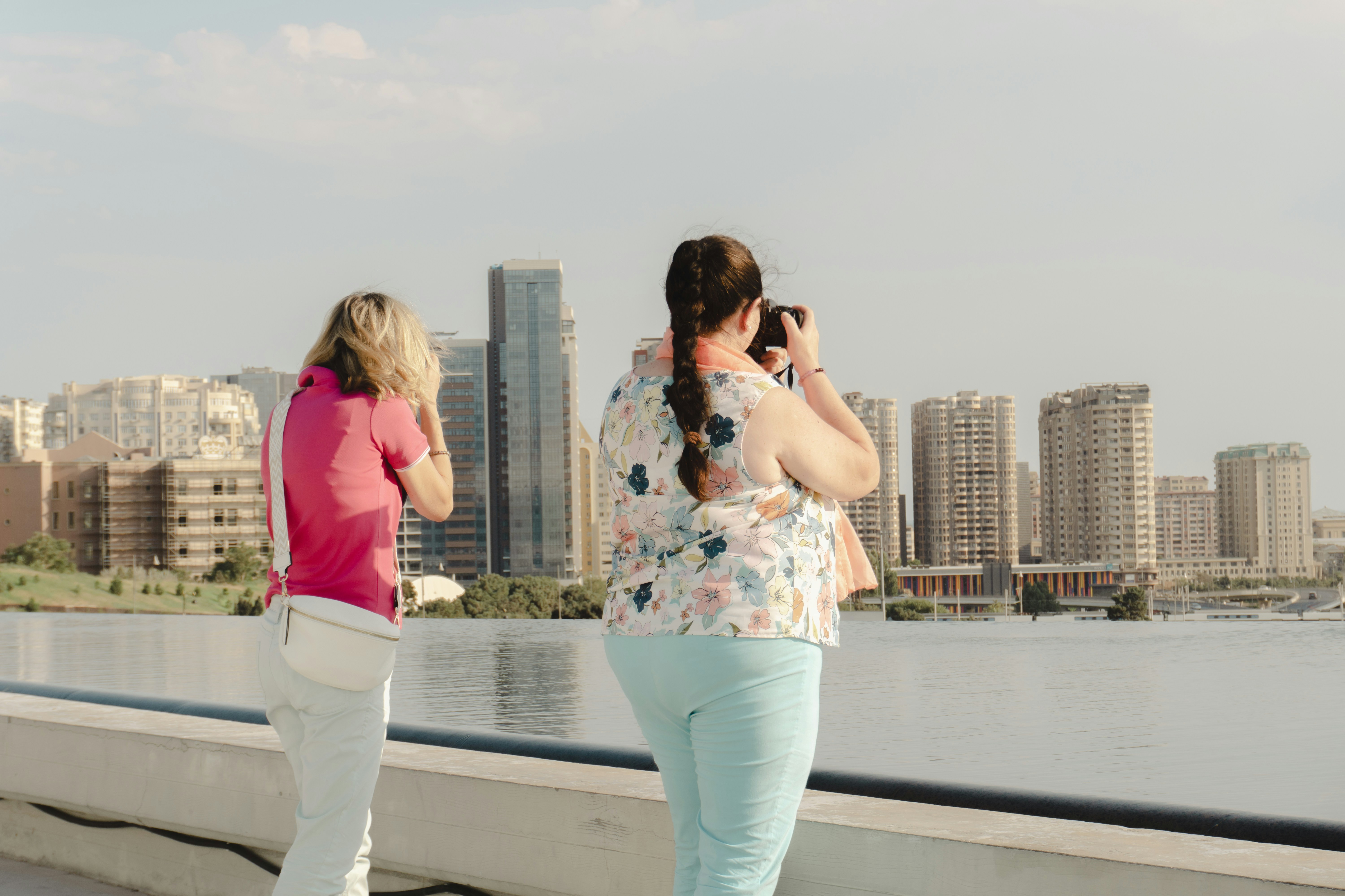 Promenade Portraits: Two Women, One City Skyline, One Waterfront Moment