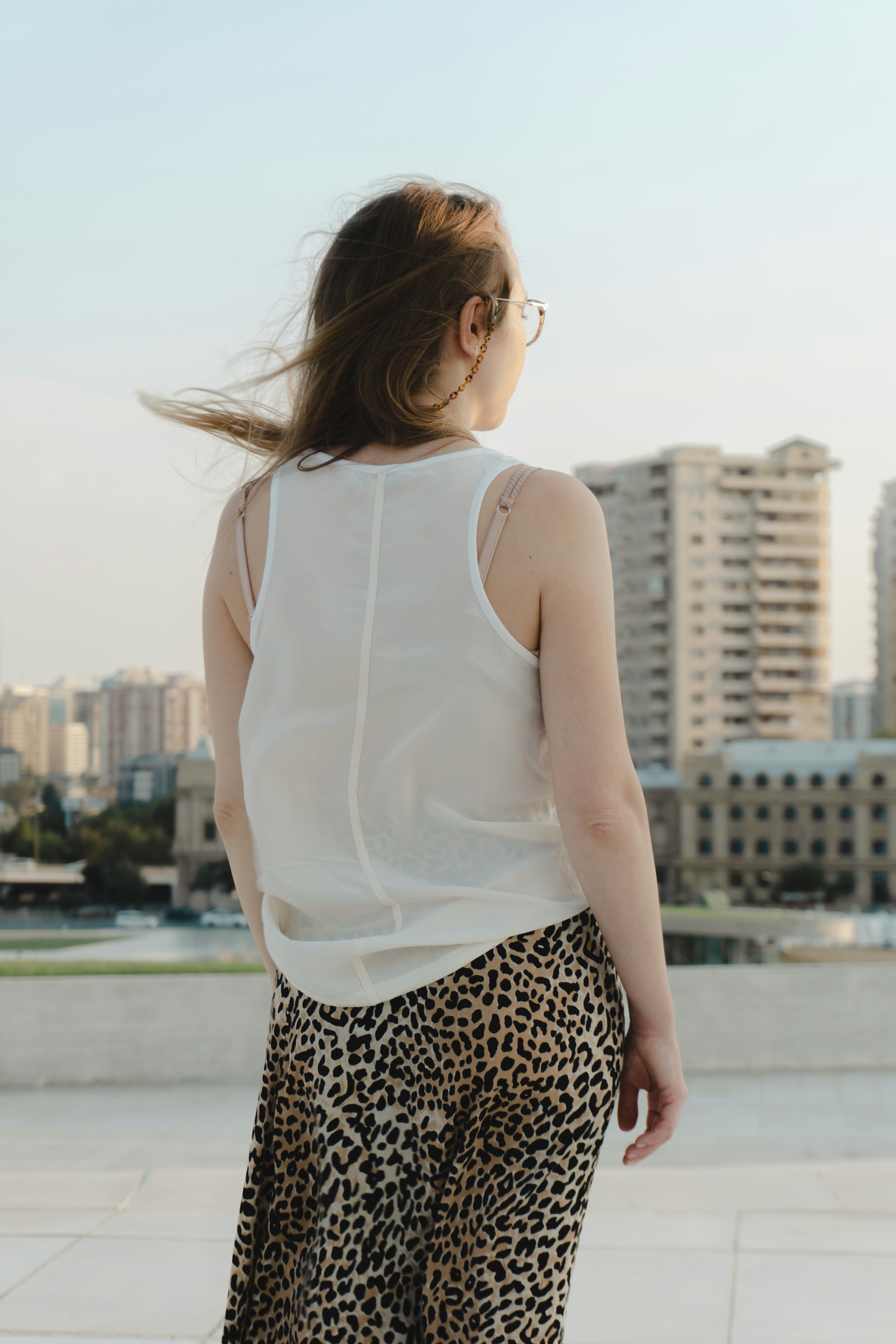 Midtown Breeze: A Back-Facing Portrait in White & Leopard Print