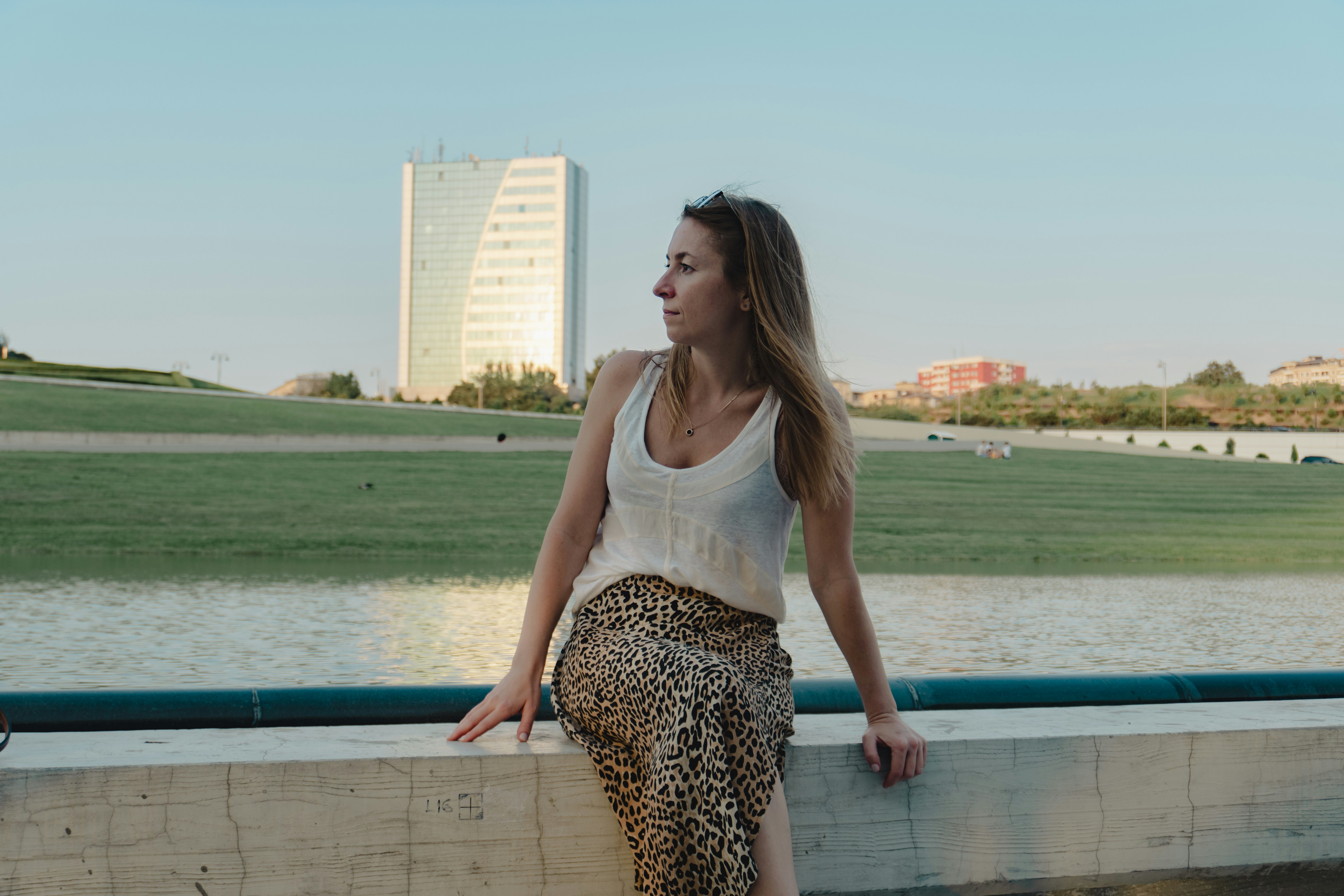 Leopard Print at Riverside: A Quiet Portrait with Urban Backdrop