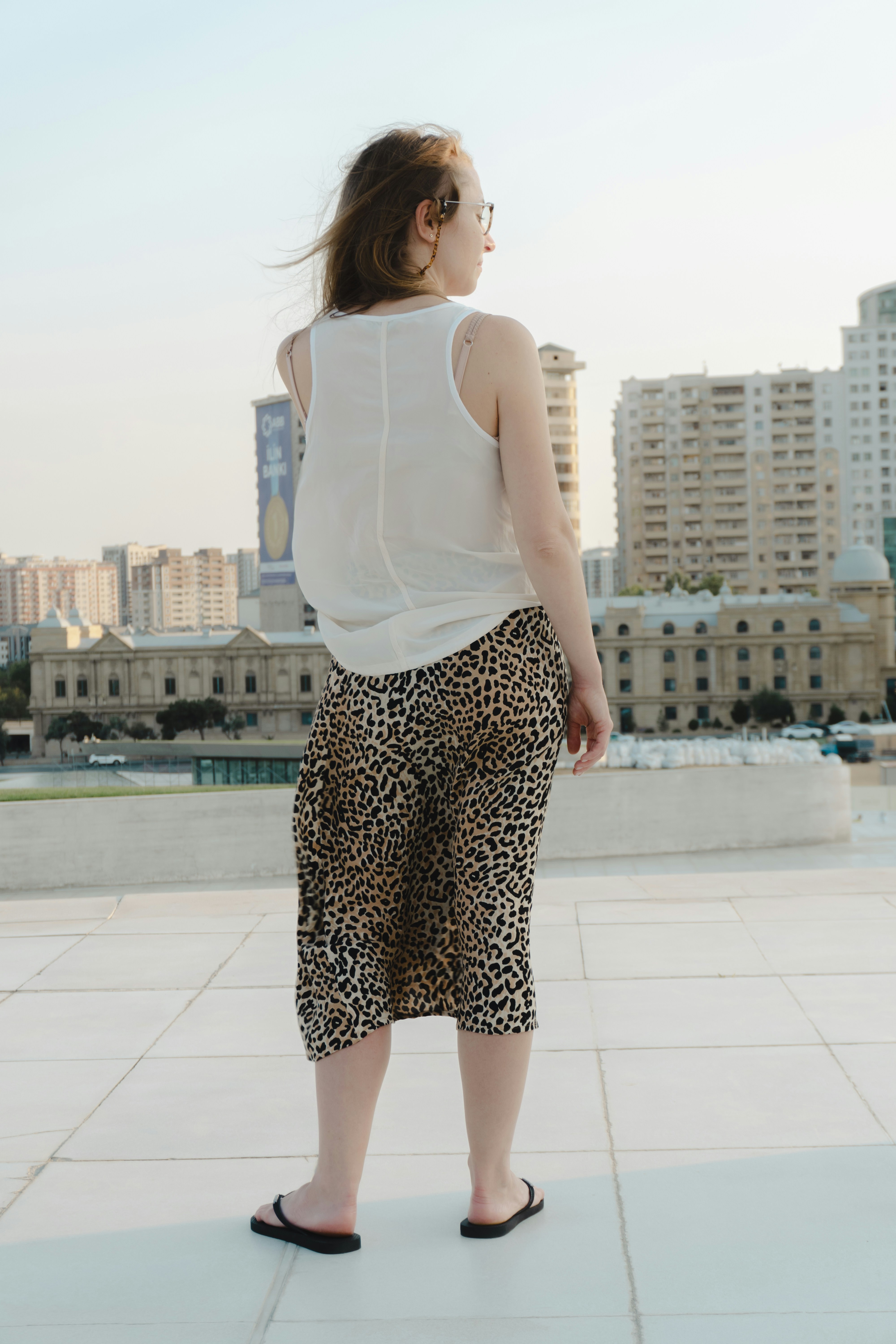 Leopard-Print Pause on a Rooftop Promenade