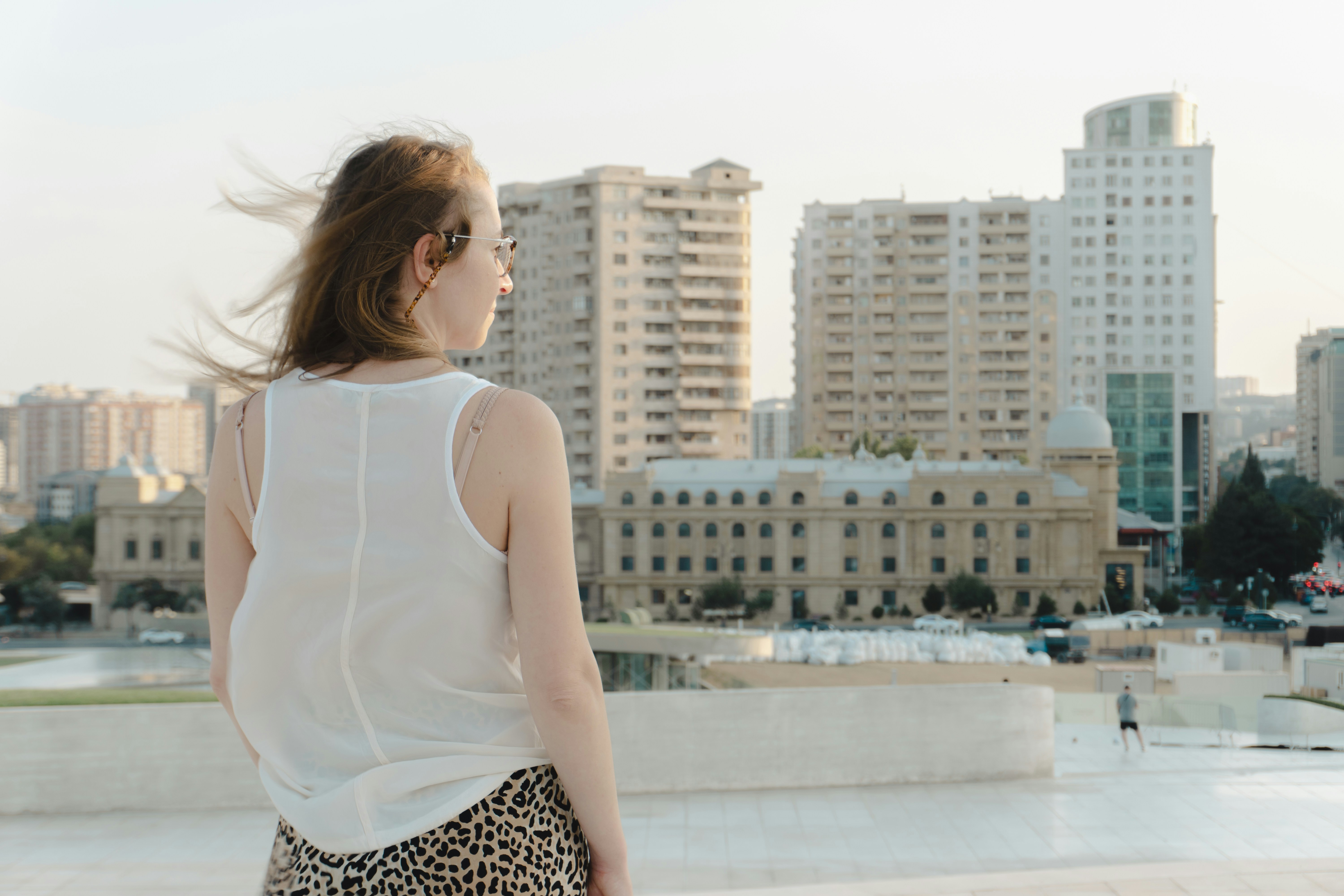 Back-View Portrait Over a Sunlit Cityscape