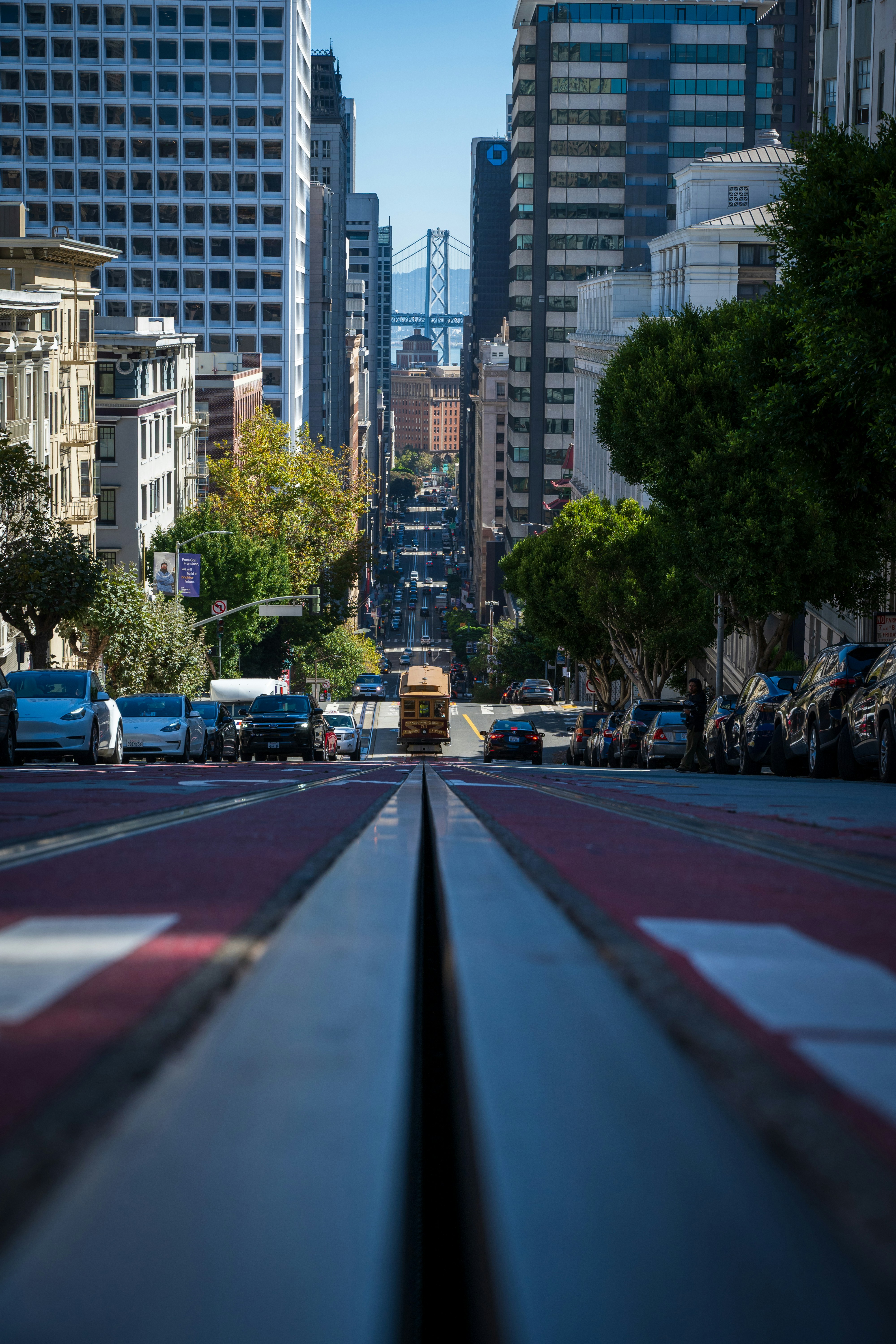 San francisco street with cable car and bridge