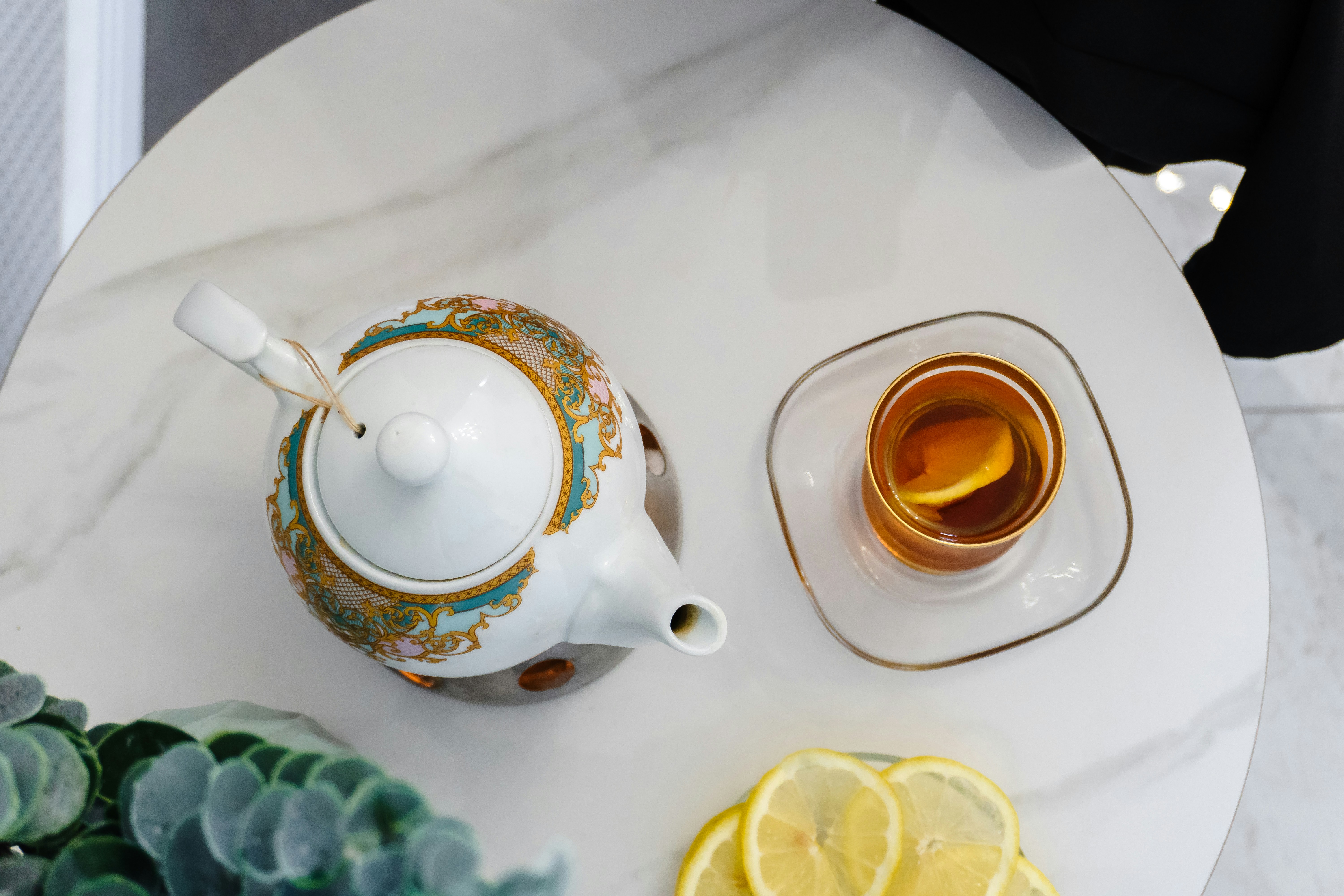 Ornate Turquoise Teapot and Lemon Accent on Marble Table