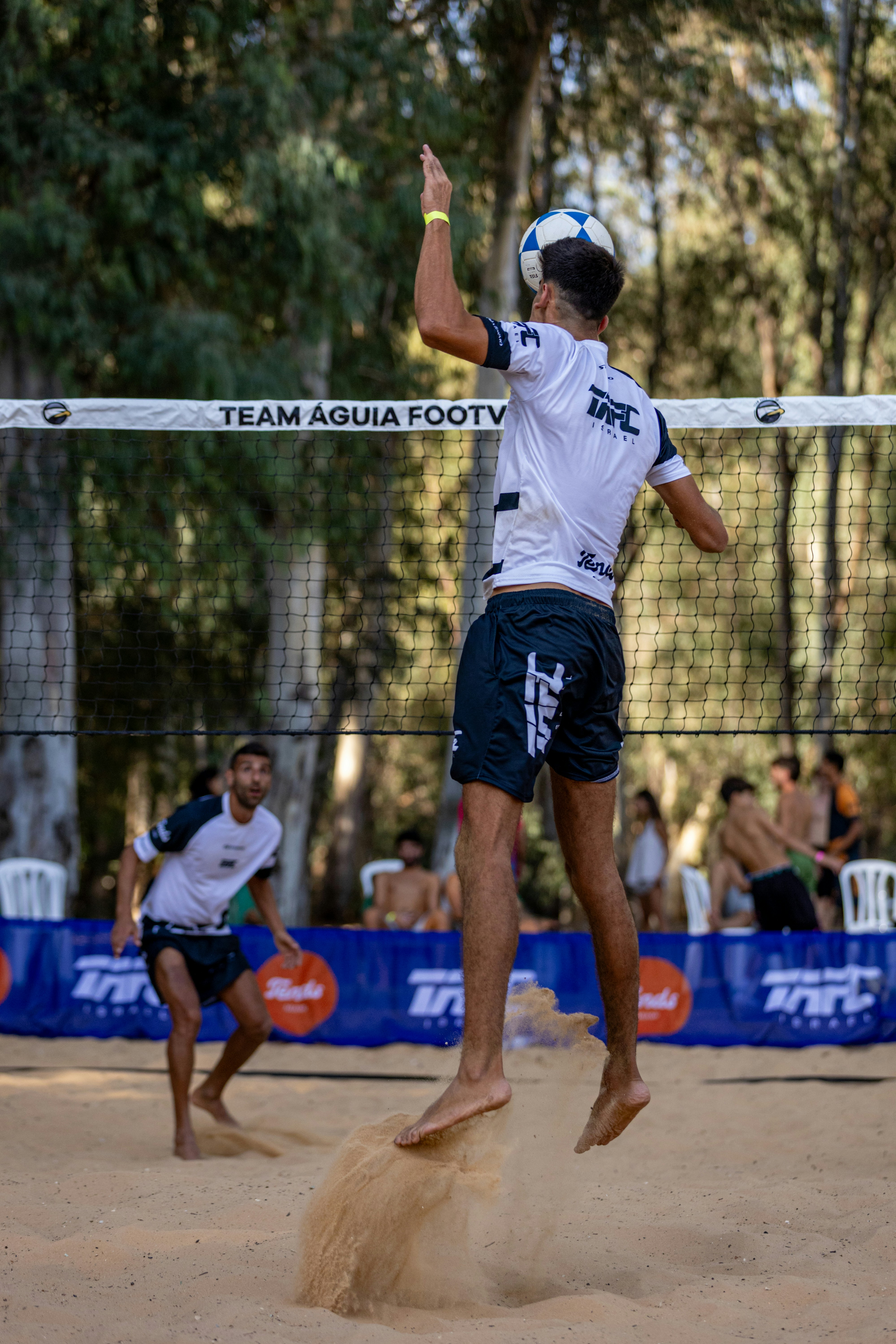 High-Flyer at the Net: A Sunlit Beach Volleyball Rally
