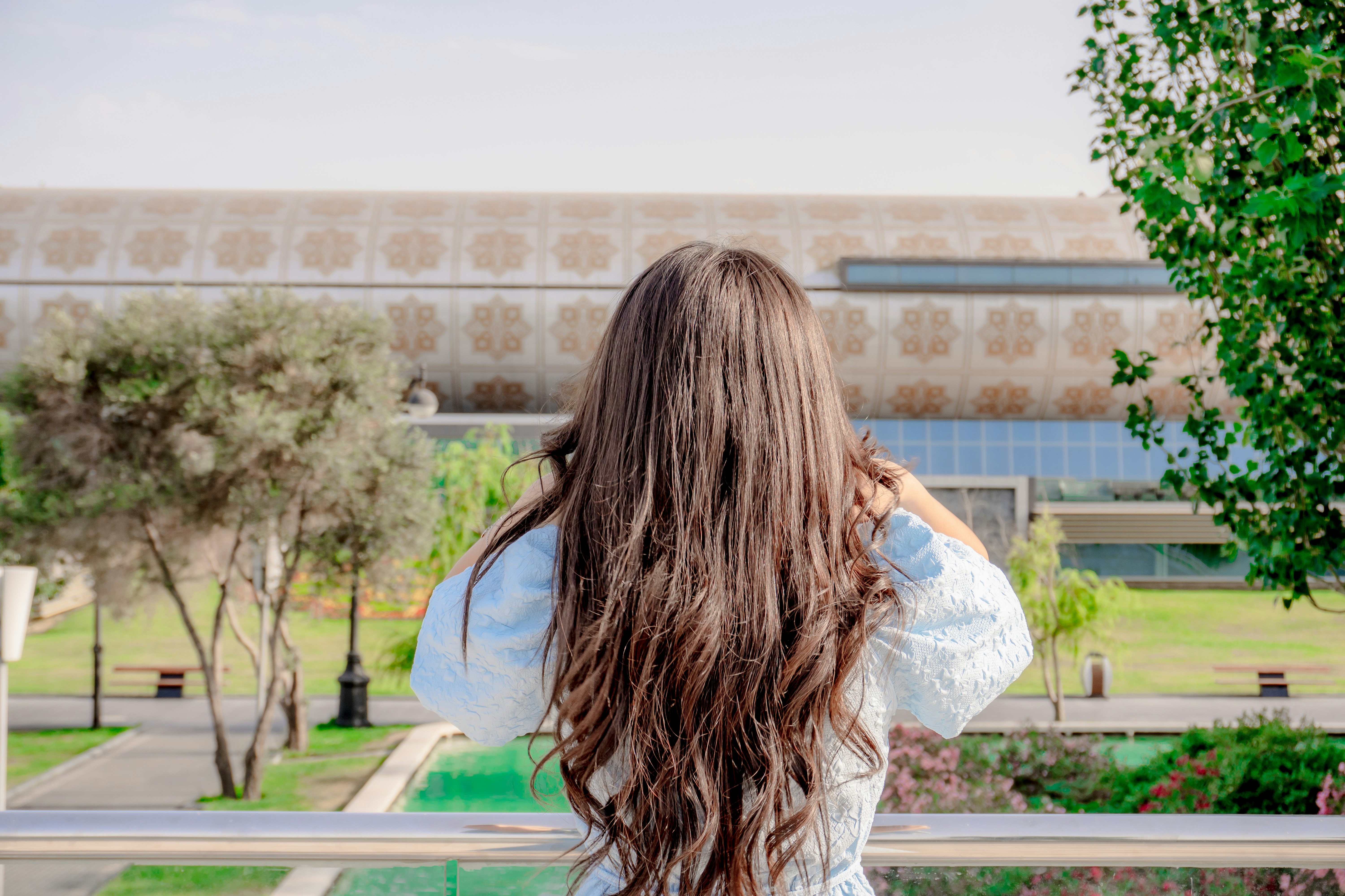 Back to Daylight: Long Hair Framing a Modern Campus Terrace
