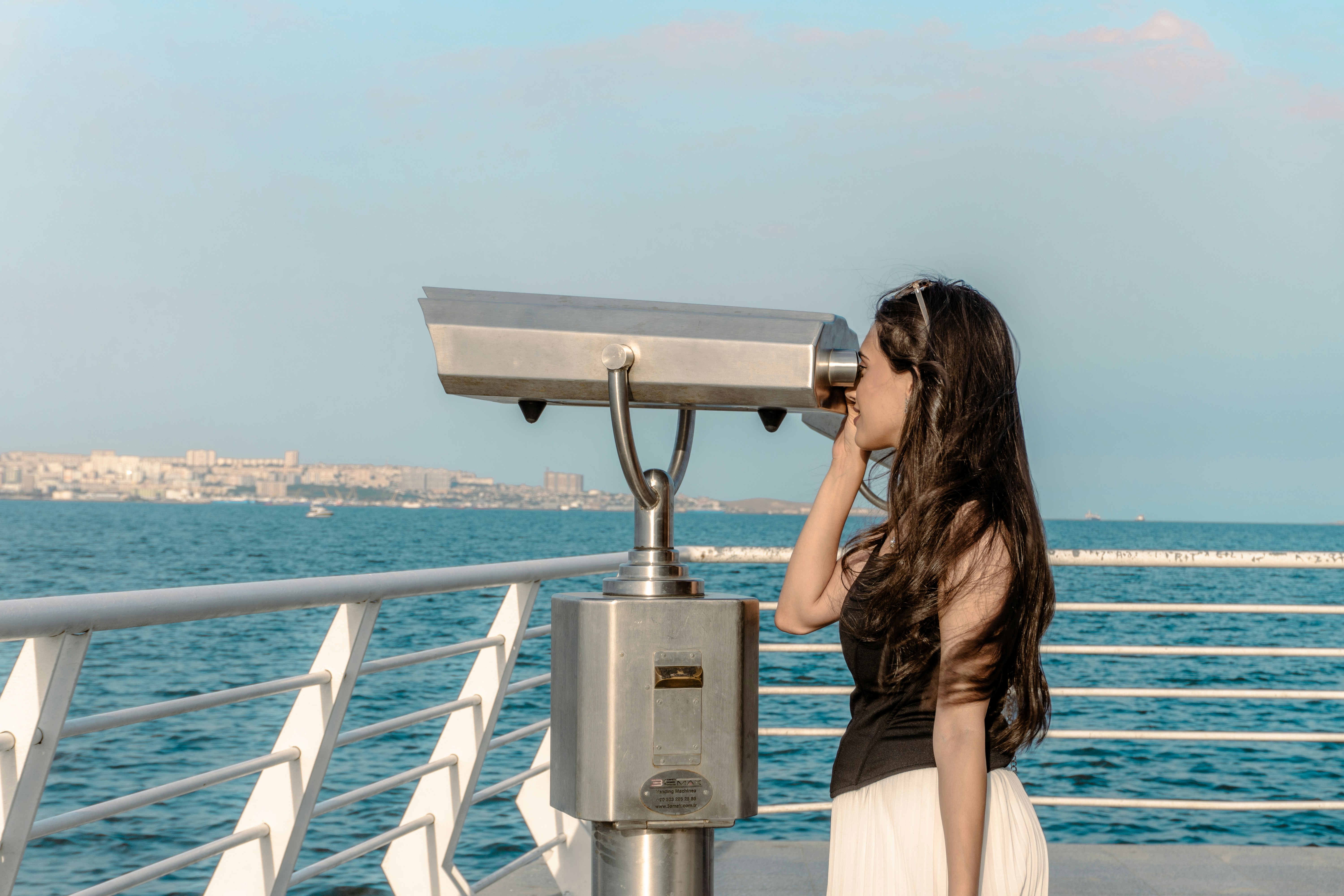 Pierside Gaze: A Woman Aligns Her View with the Sea through a Binocular Viewer