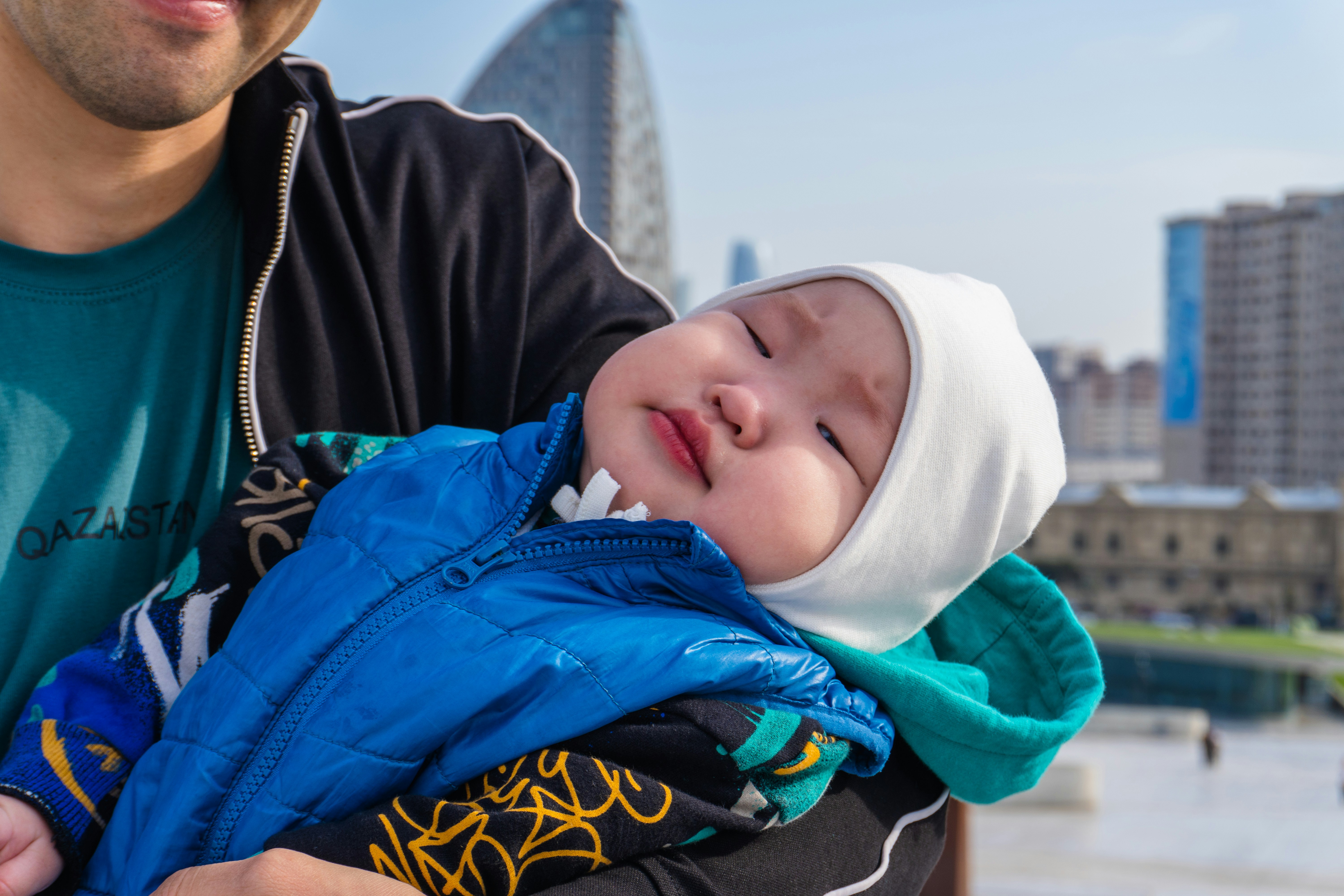 Harbor Calm: Baby Nap Amid Urban Light by the Waterfront