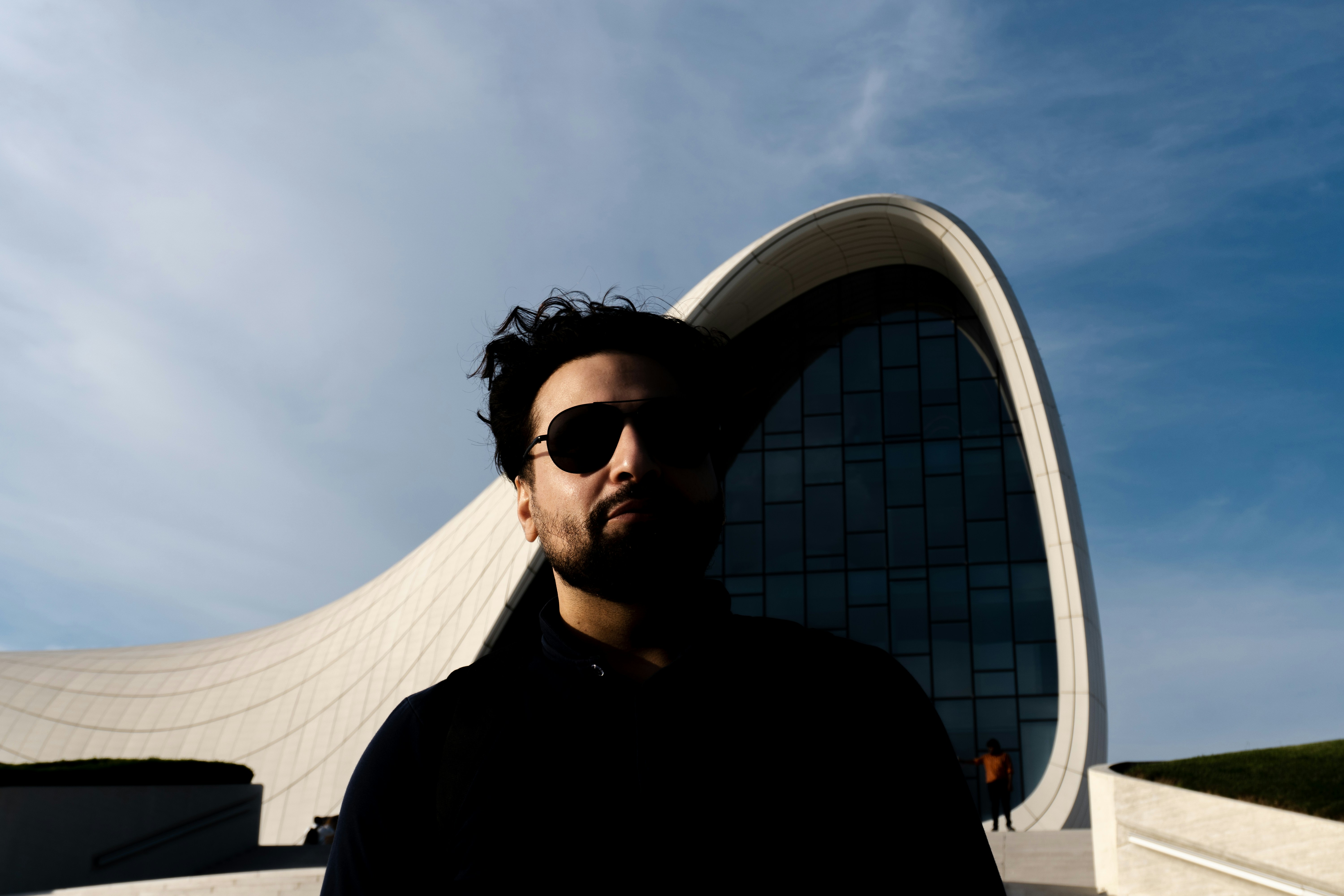 Silhouette in the Curve: Portrait Before a Modern Arch