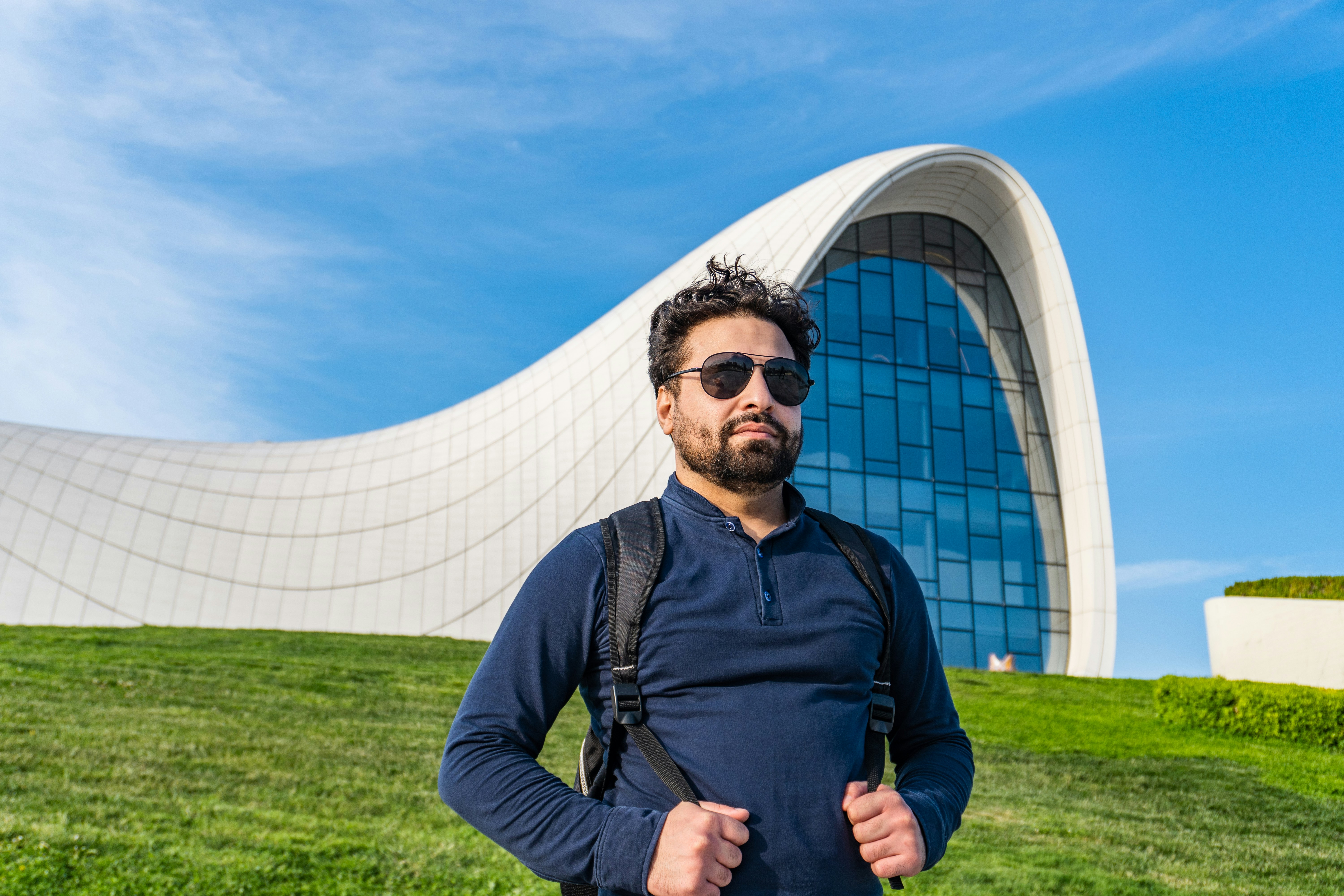 Portrait on a Modern Canvas: Man in Front of Curved Glass Architecture