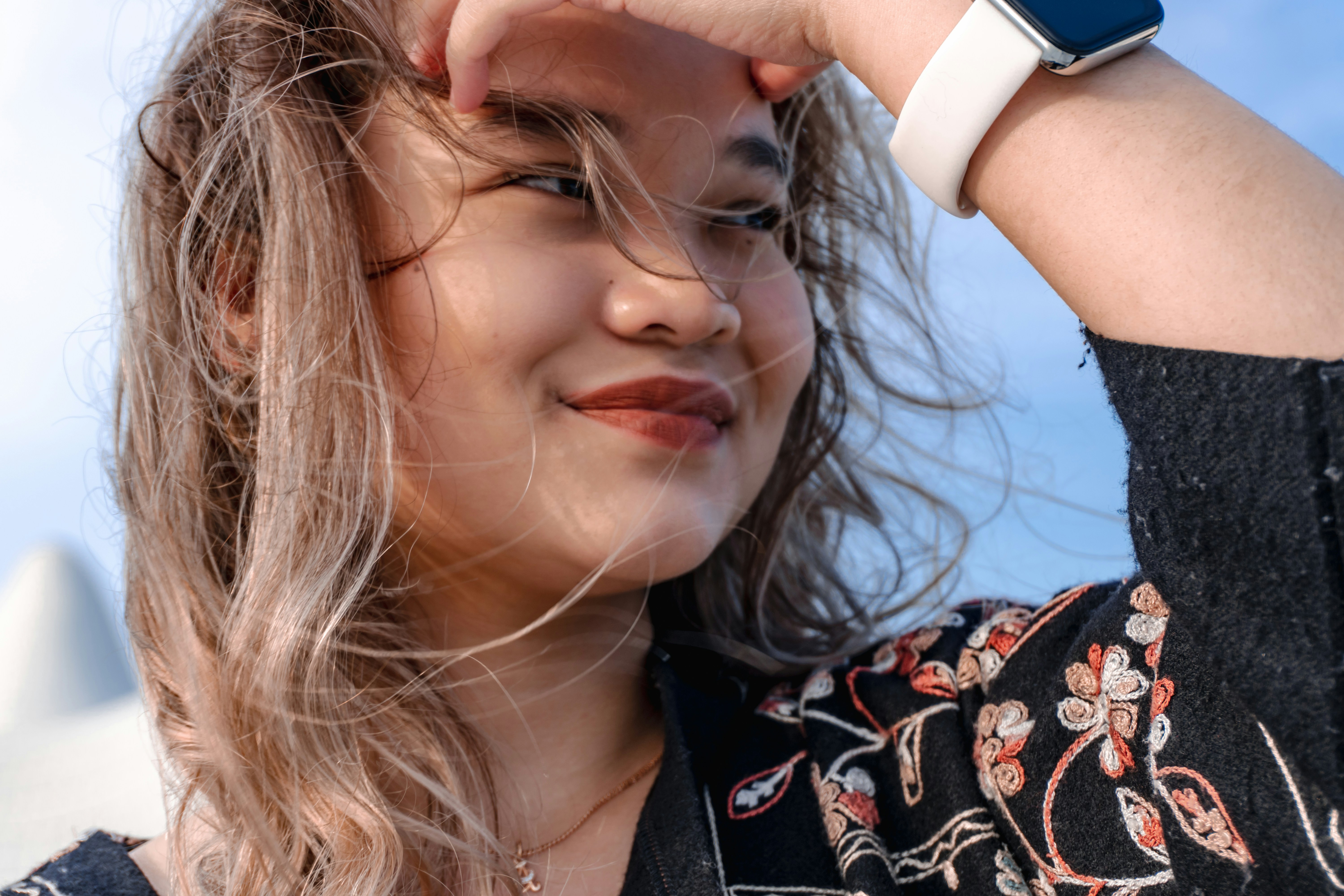 Sunlit Smile, Wind-Tossed Hair: A Portrait of Quiet Joy