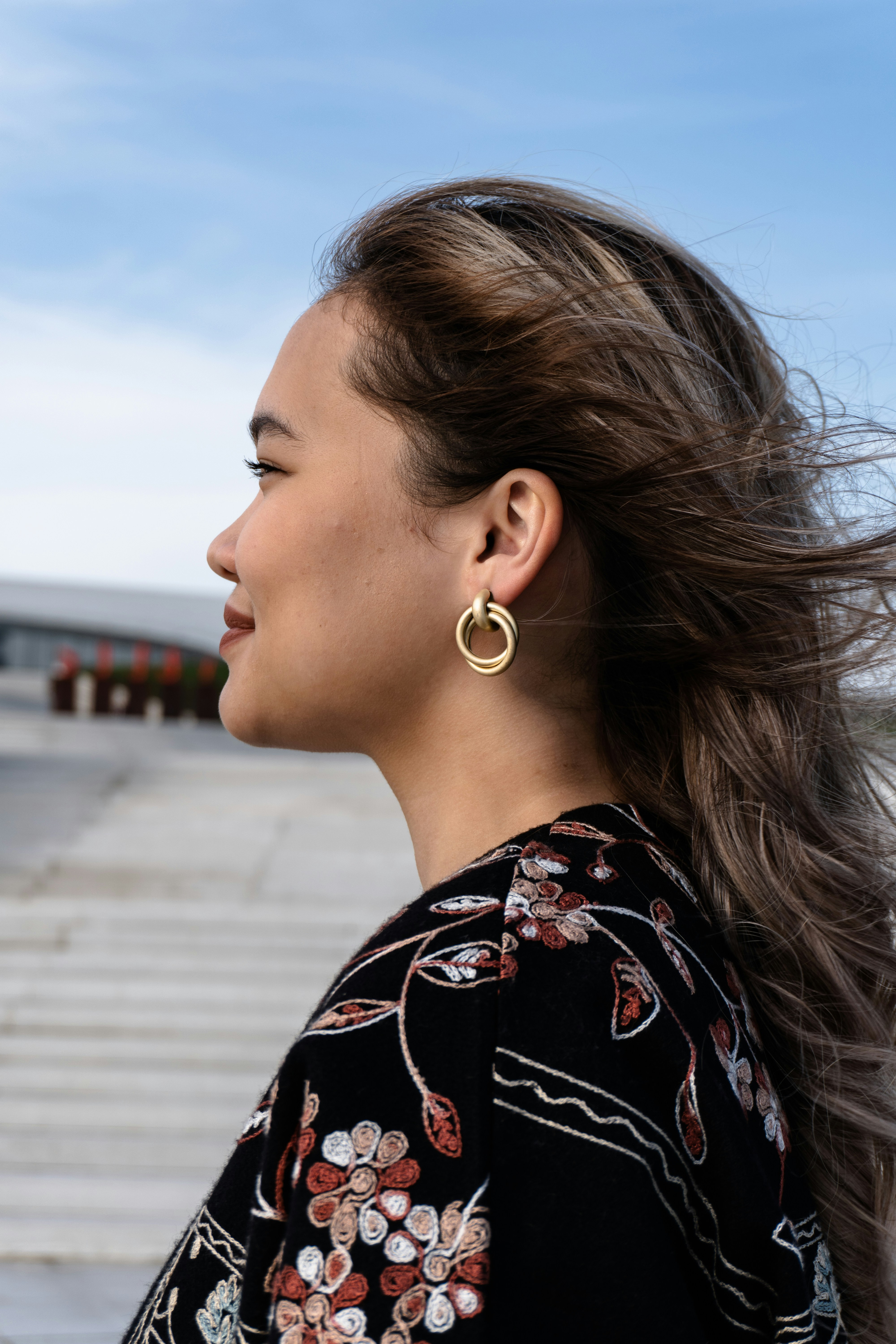 Wind-Swept Profile by Urban Steps: Floral Embroidery and Gold Hoops