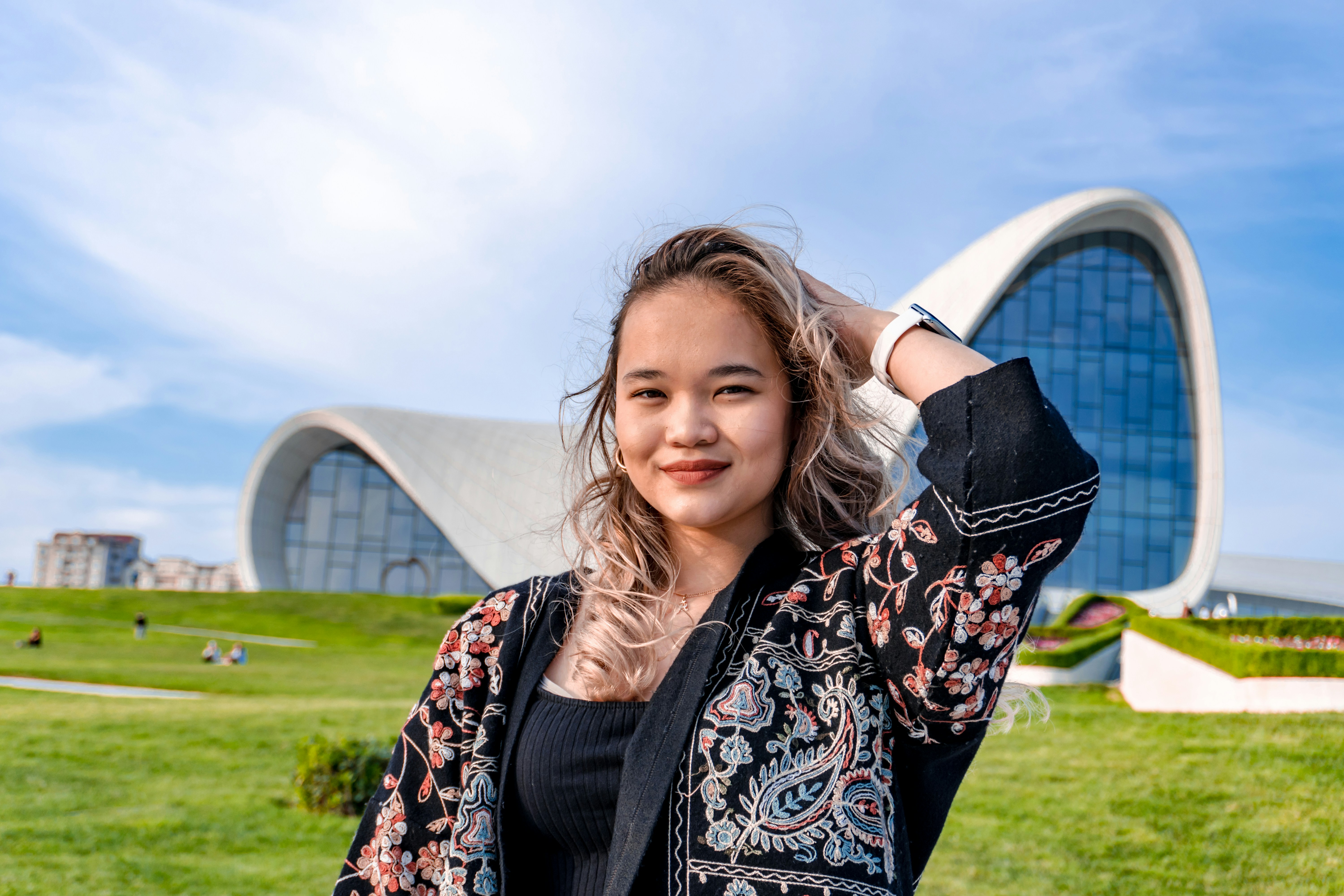 Portrait Beneath the Glass Arches: A Sunlit Moment with Modern Curves