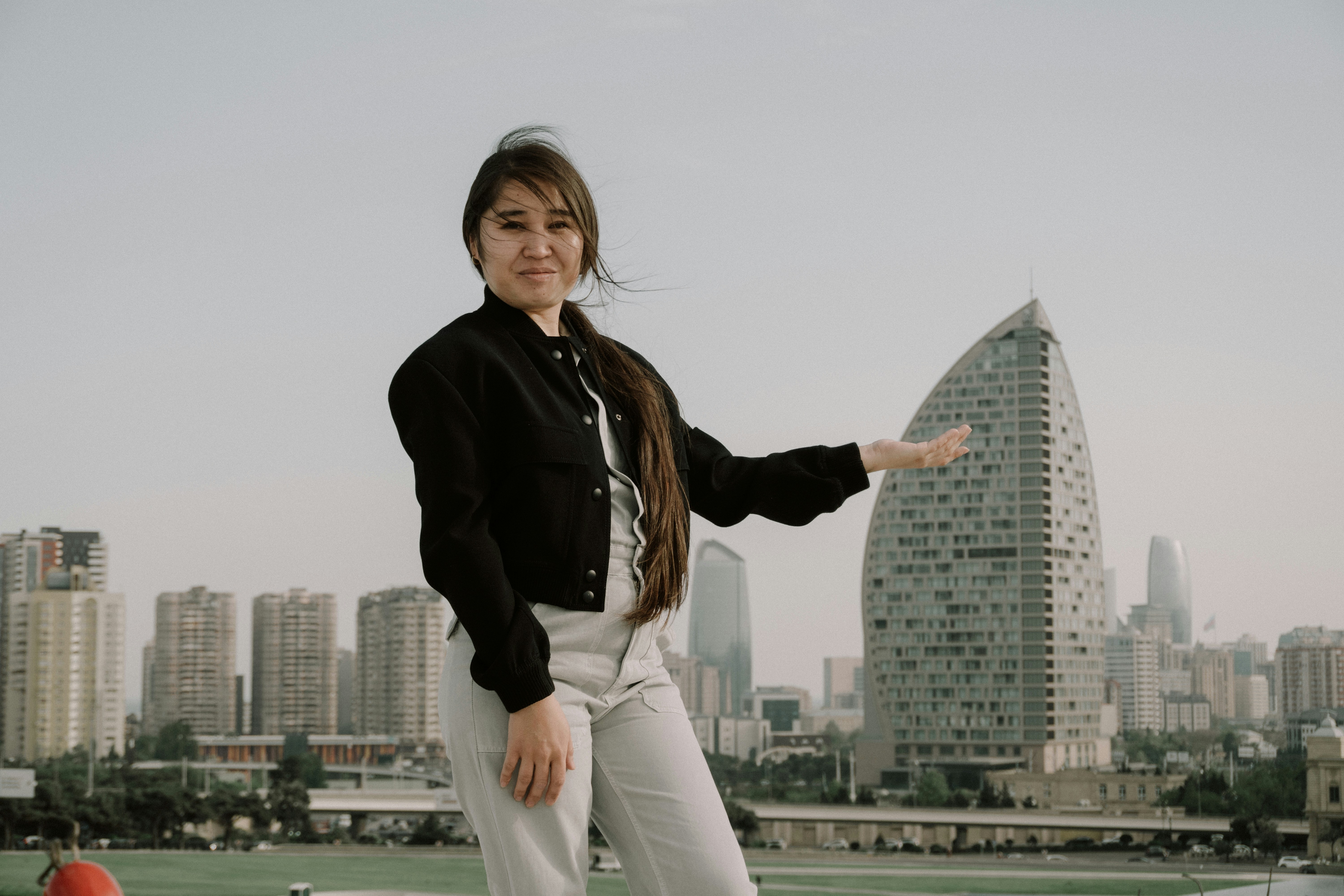 Urban Muse: A Casual Pose at the Riverside Skyline