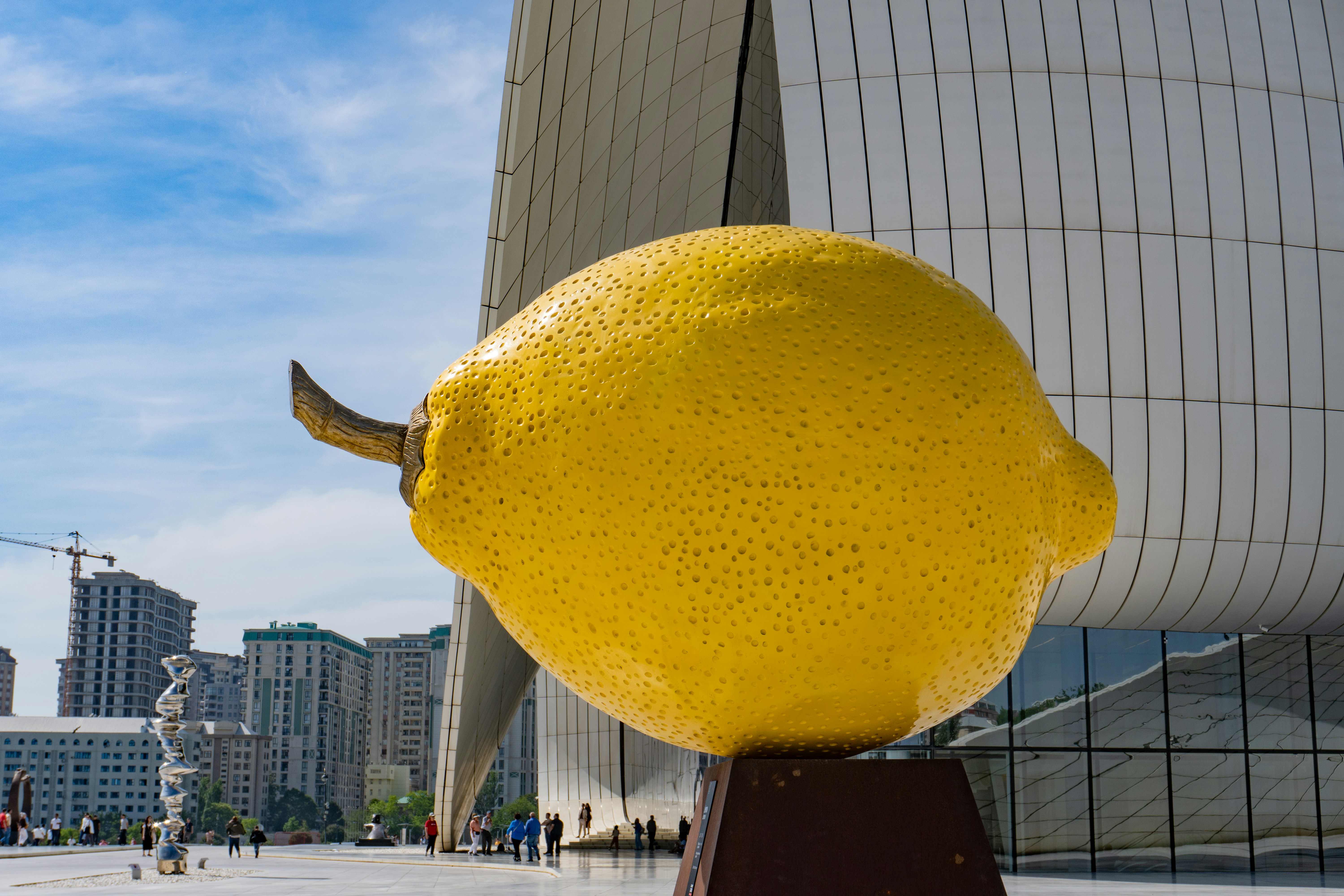 Giant Lemon Sentinel by the Glass Facade