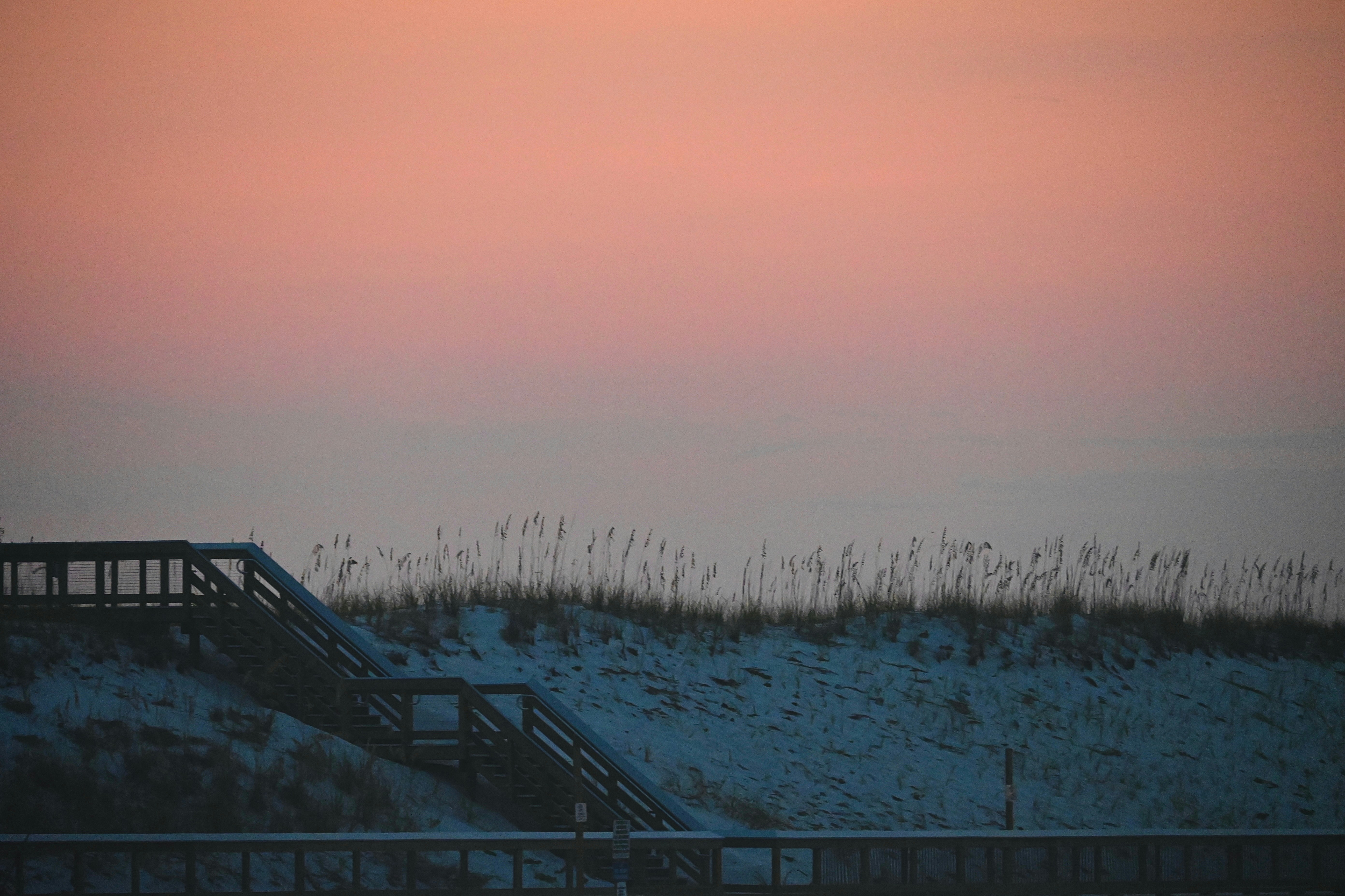 Pastel Dunes at Dusk: A Quiet Boardwalk Leads to the Horizon