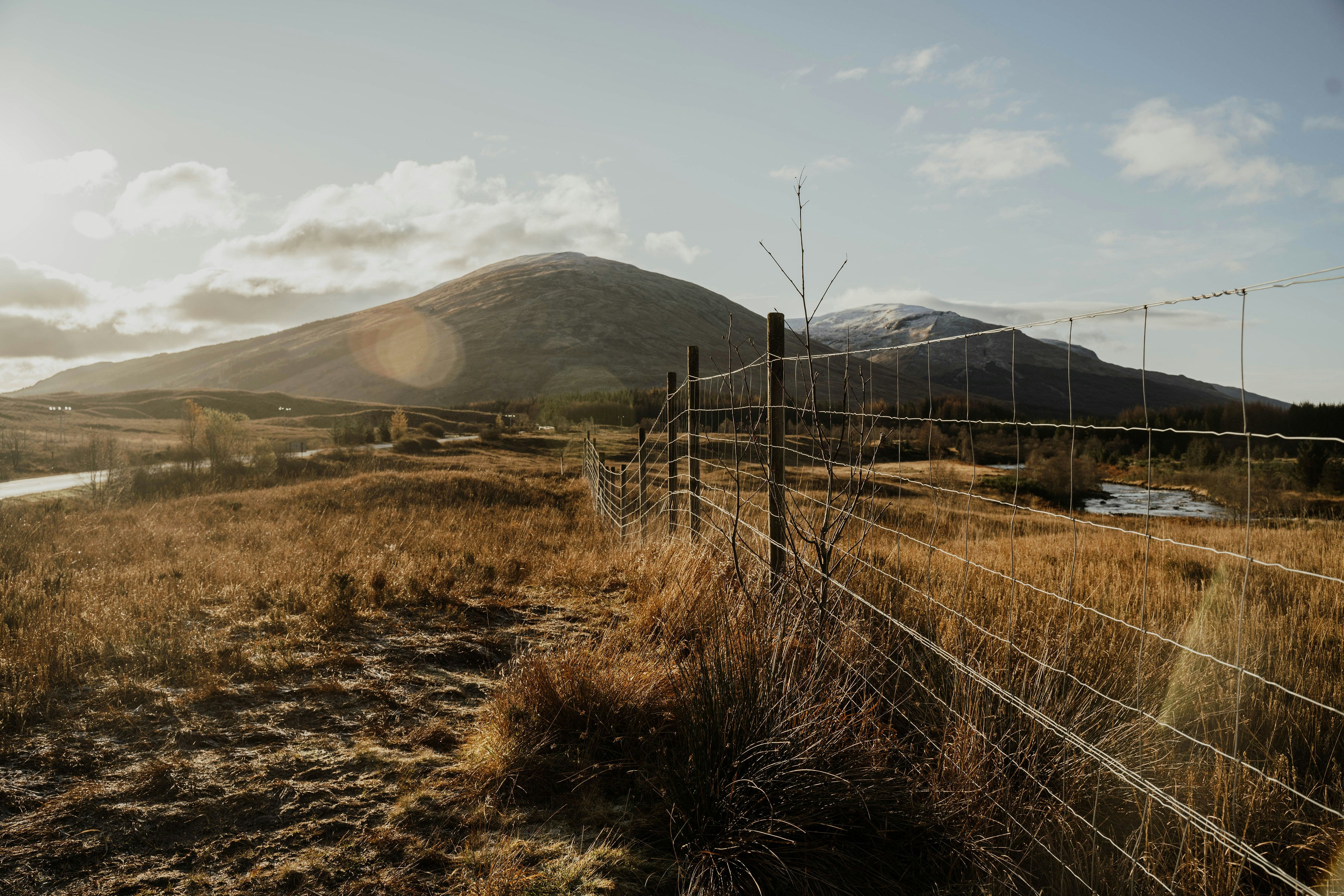 Golden Hour Fence: A Quiet Moor Reaches Toward Distant Hills