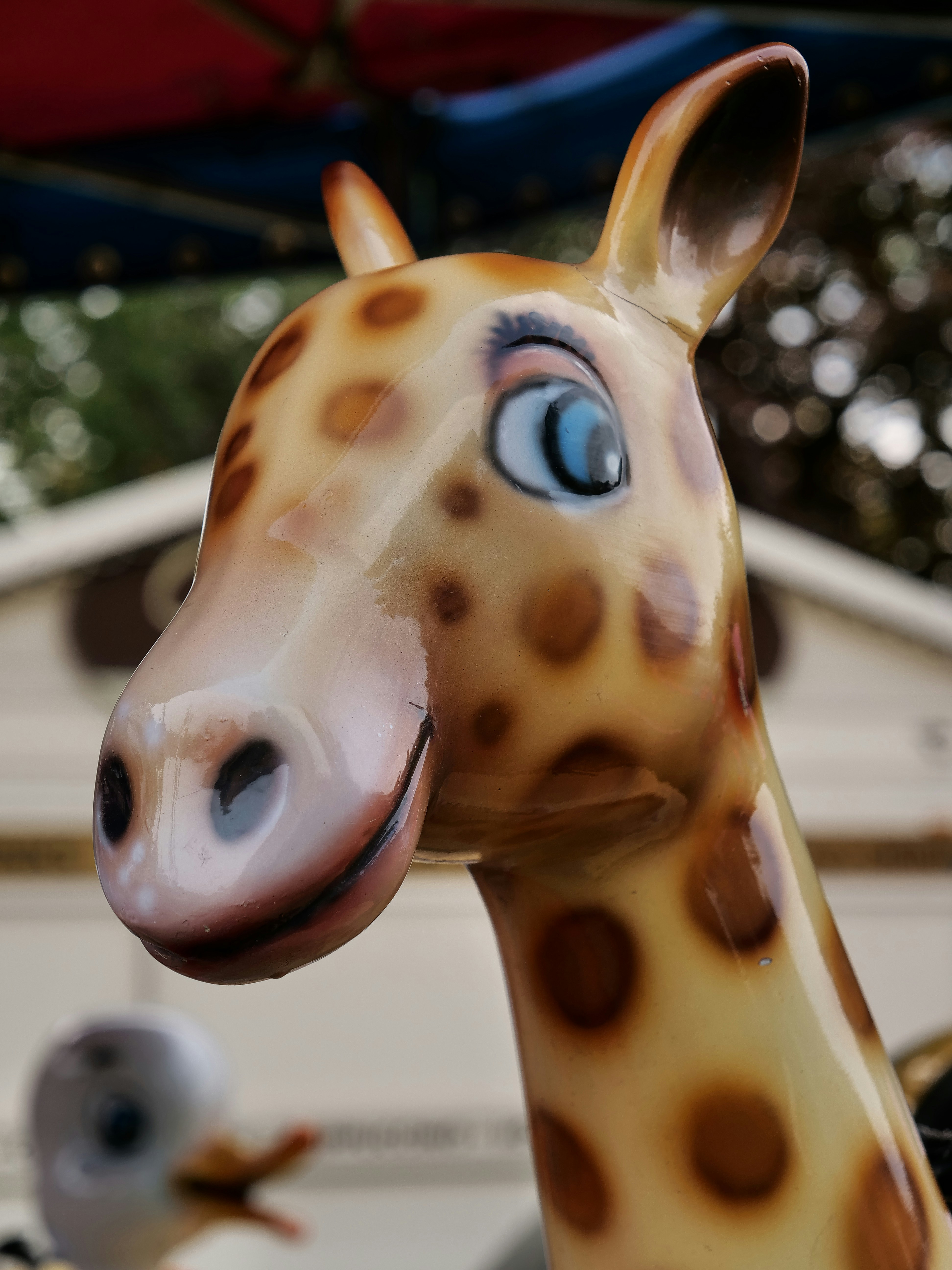 Carousel Giraffe Close-Up: Polished Spots and a Playful Gaze