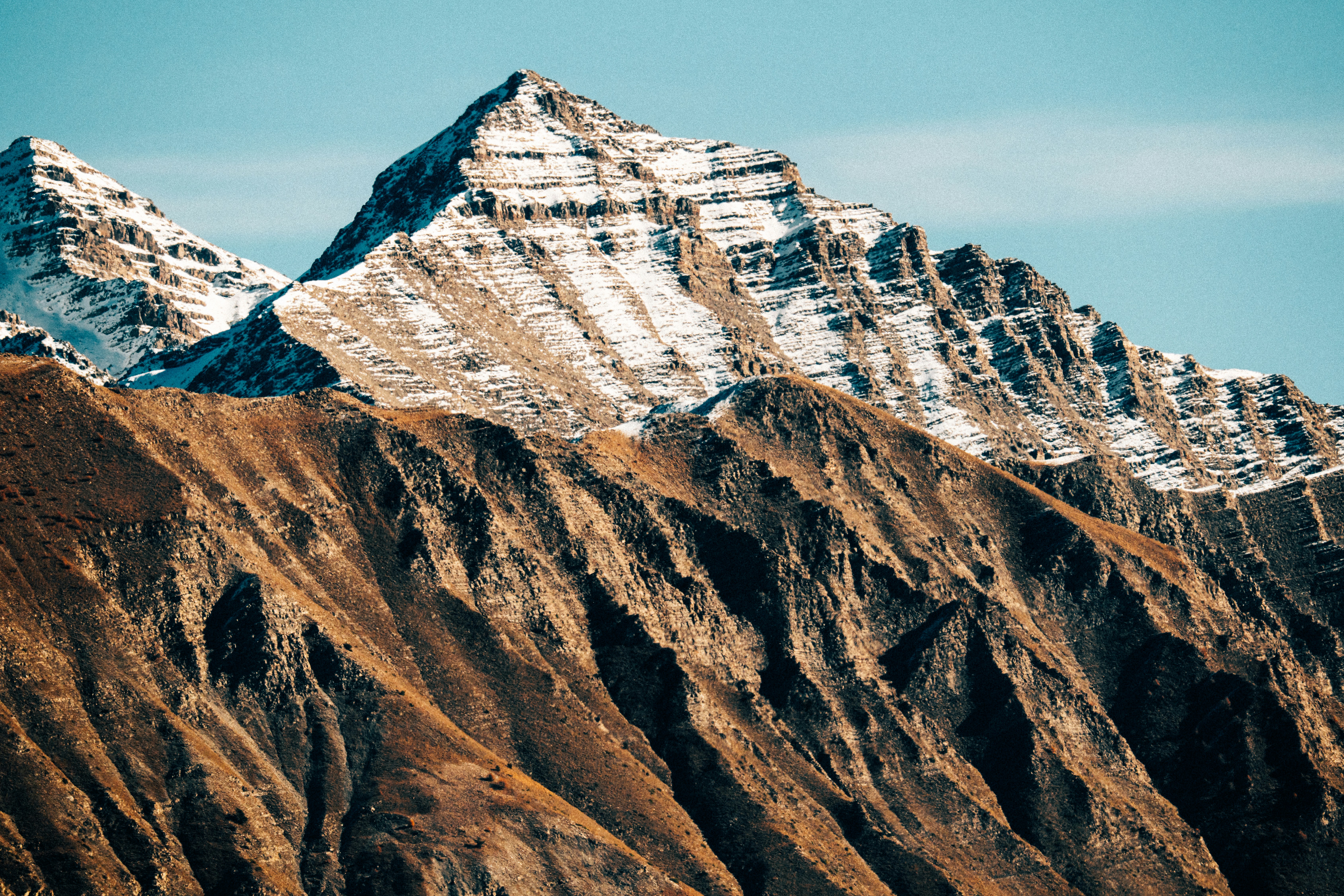 Alpine Crown: Snow-Tipped Peaks Above a Sunlit Ridge