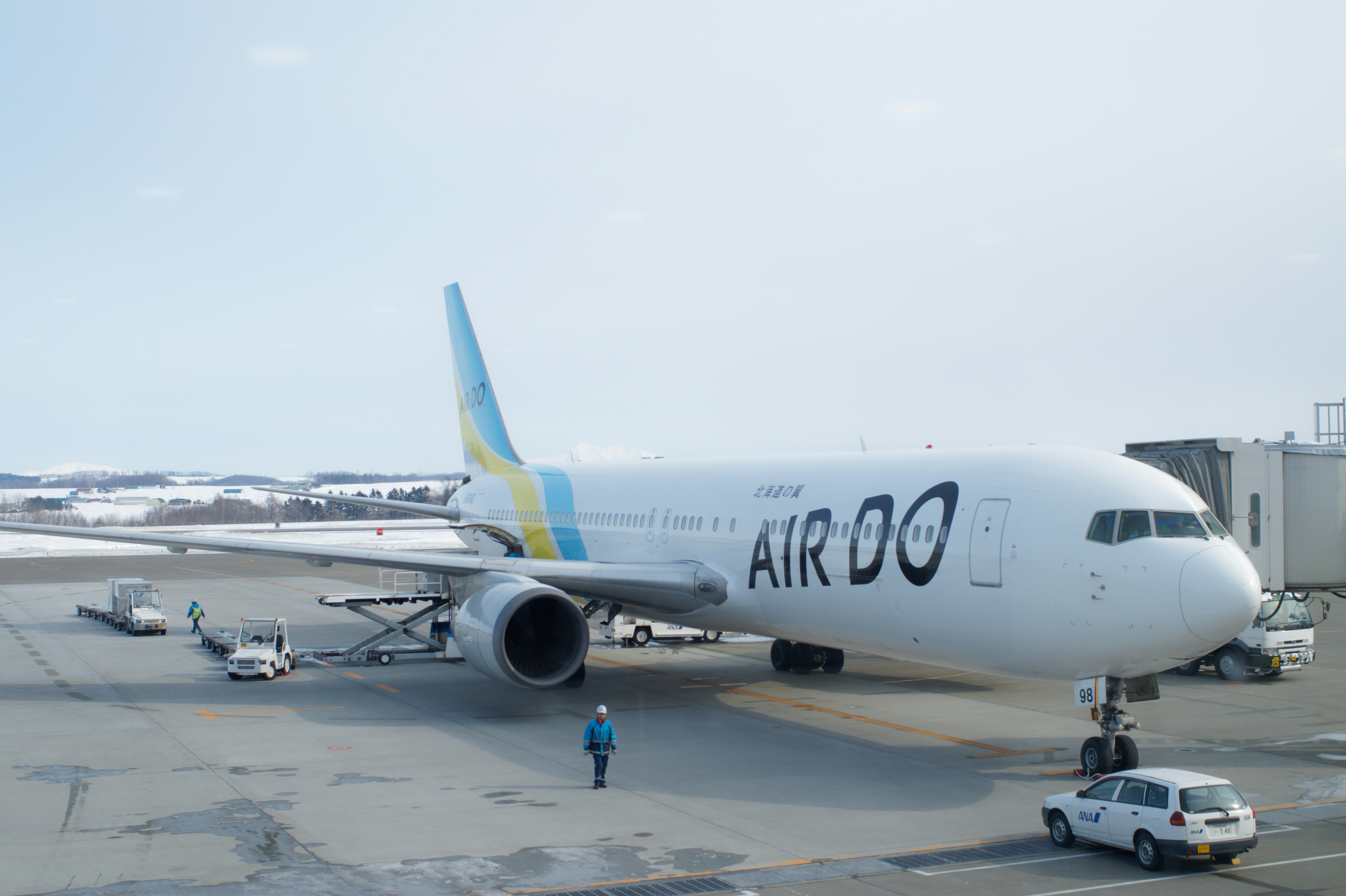 Gatefront Silence: Air Do's Blue-Yellow Jet Anchored at the Tarmac