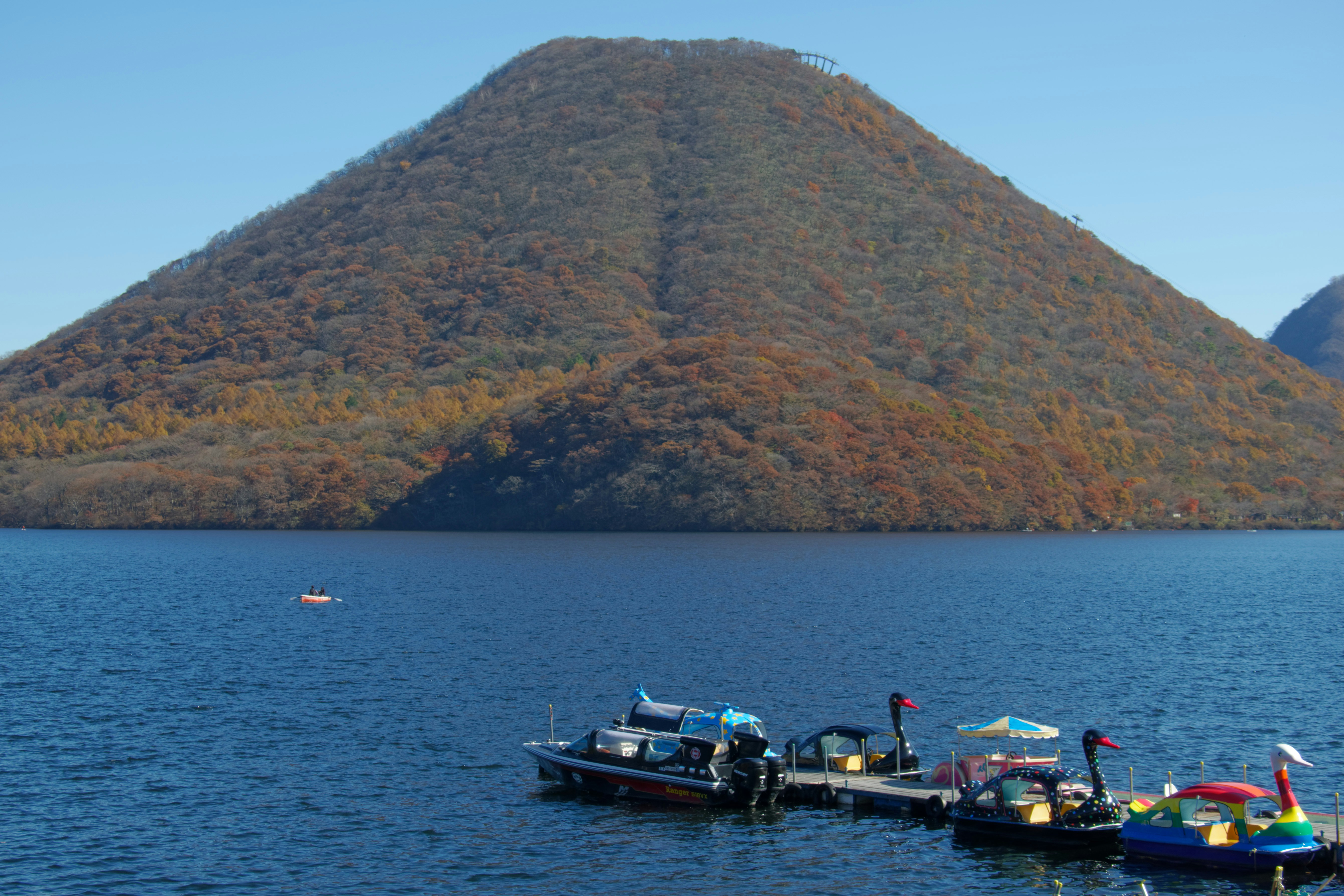 Ember Peak Looms Over a Quiet Lake, Boats Rest at the Dock