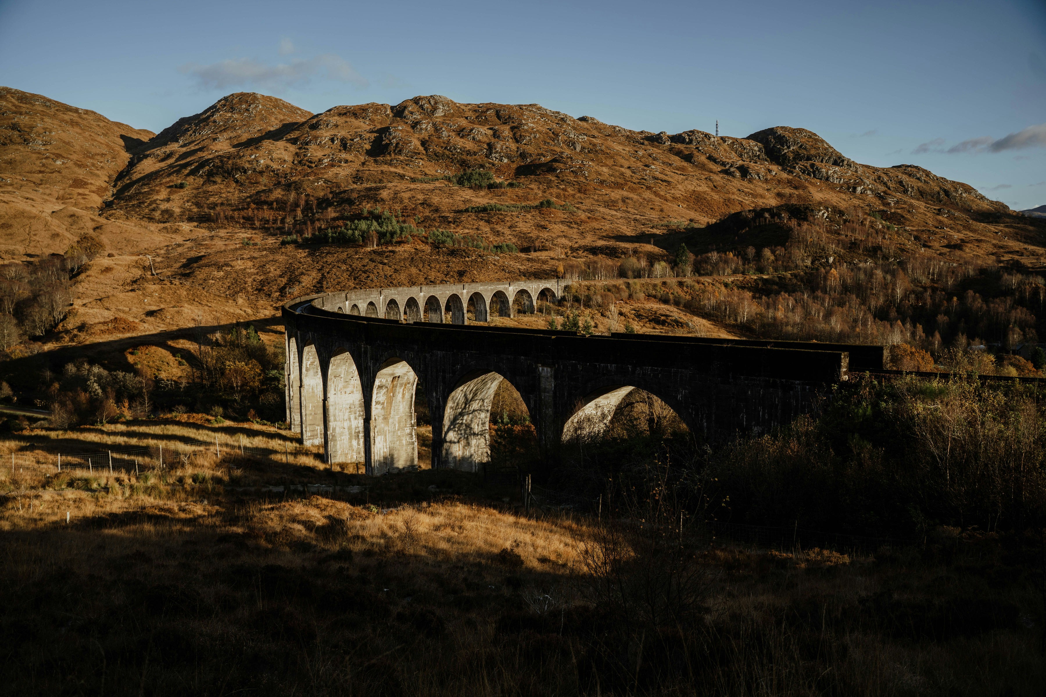 Golden Hour Arches: A Stone Viaduct Carved into Bronze Hills