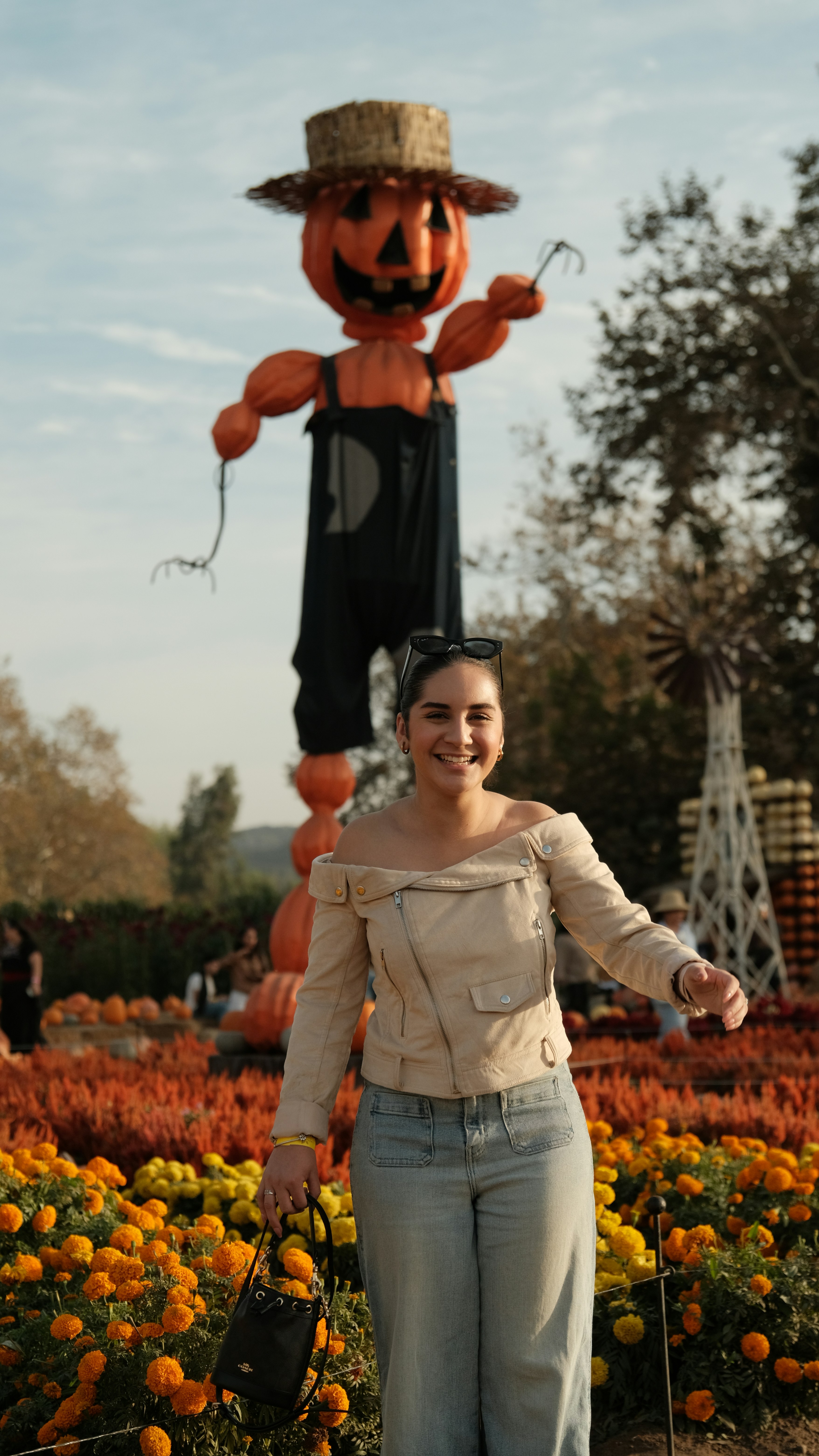 Portrait Amid Fall Colors with a Towering Pumpkin Scarecrow