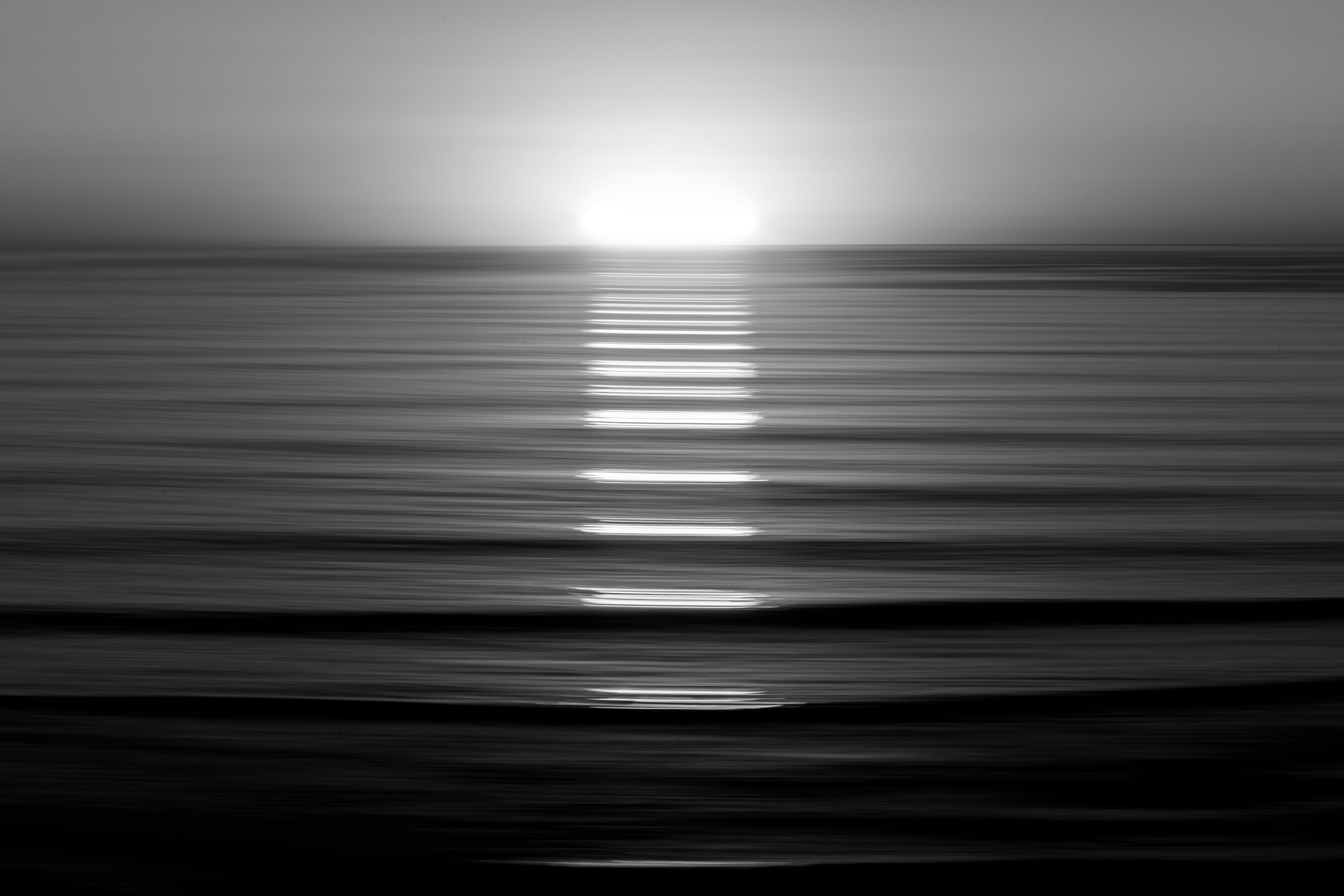 Streaked Solitude over the Monochrome Sea at Sunset