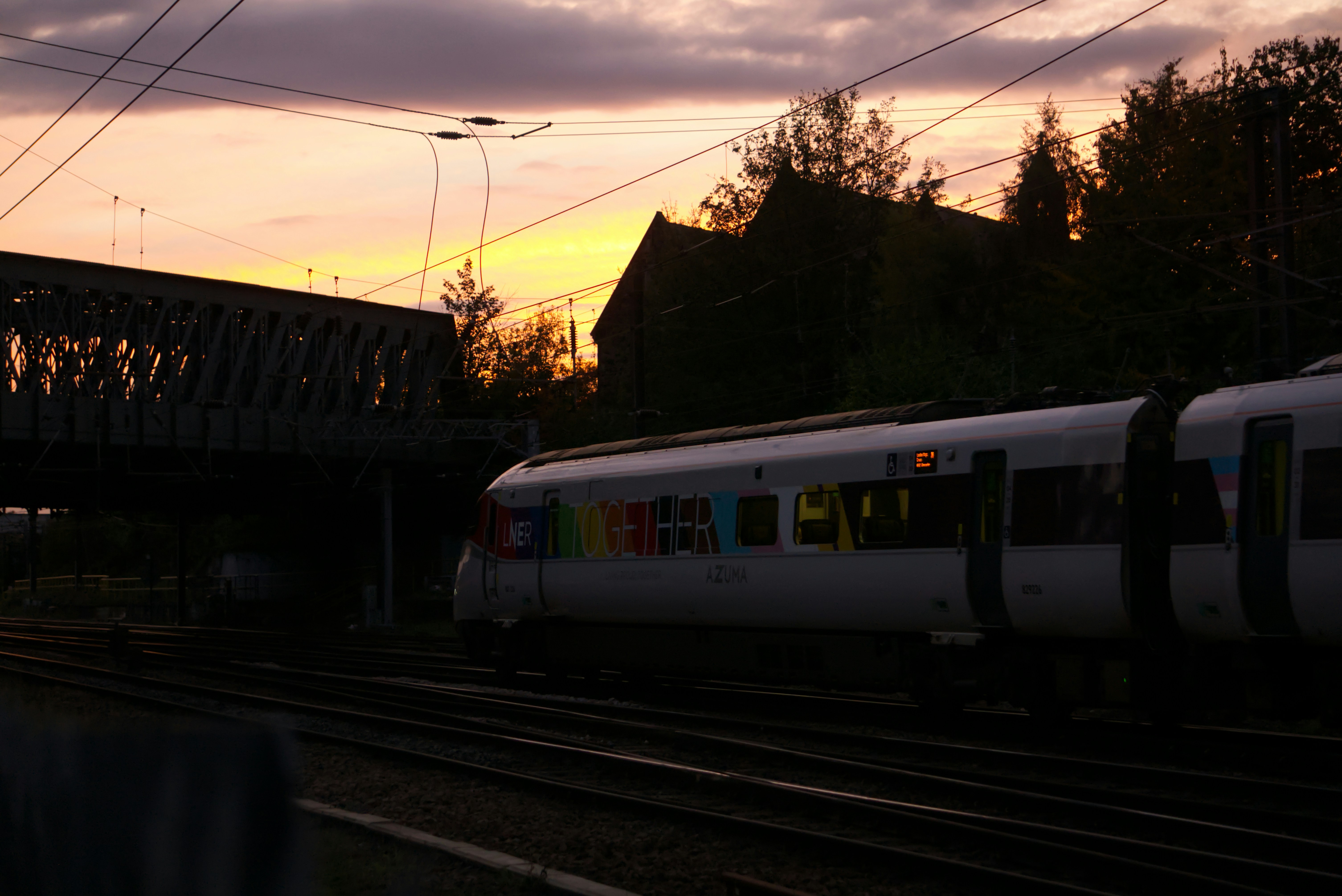 Dusk on the Rails: Sunset Train with a Colorful Side Panel