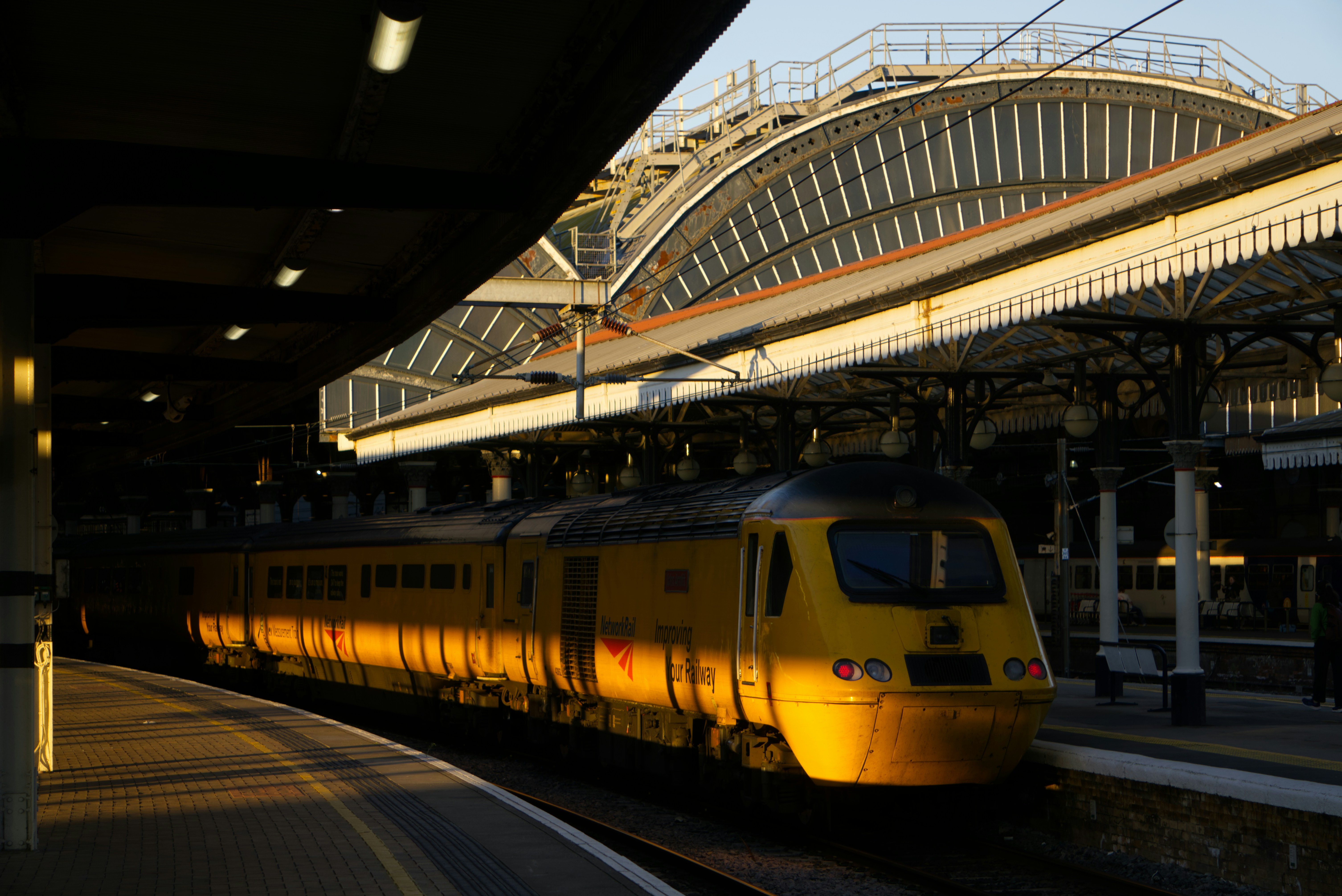 Amberliner at Dusk: A Yellow Train Beneath the Cathedral of Steel