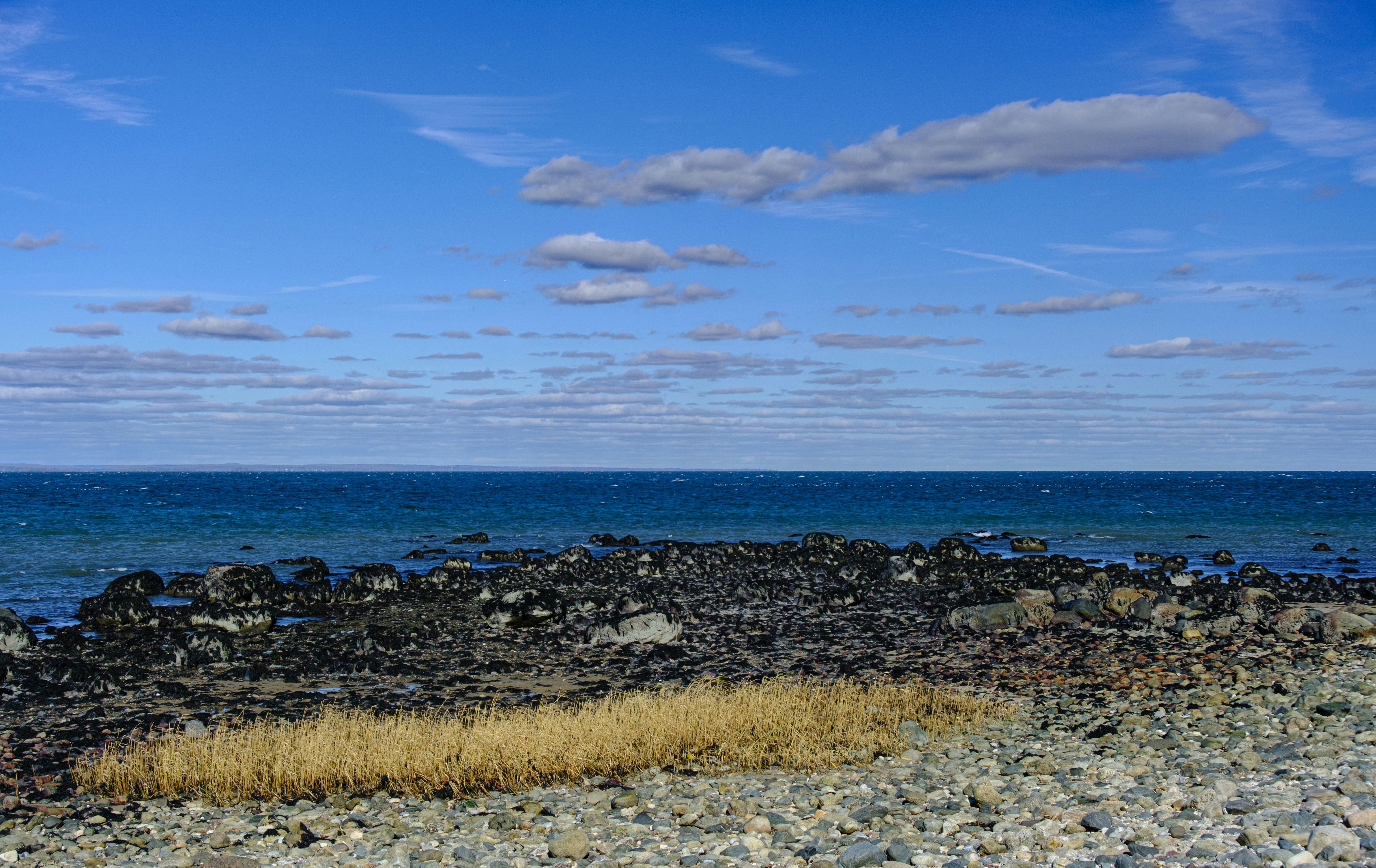 Pebble Strand: Grass-Topped Foreshore Meets a Calm Atlantic