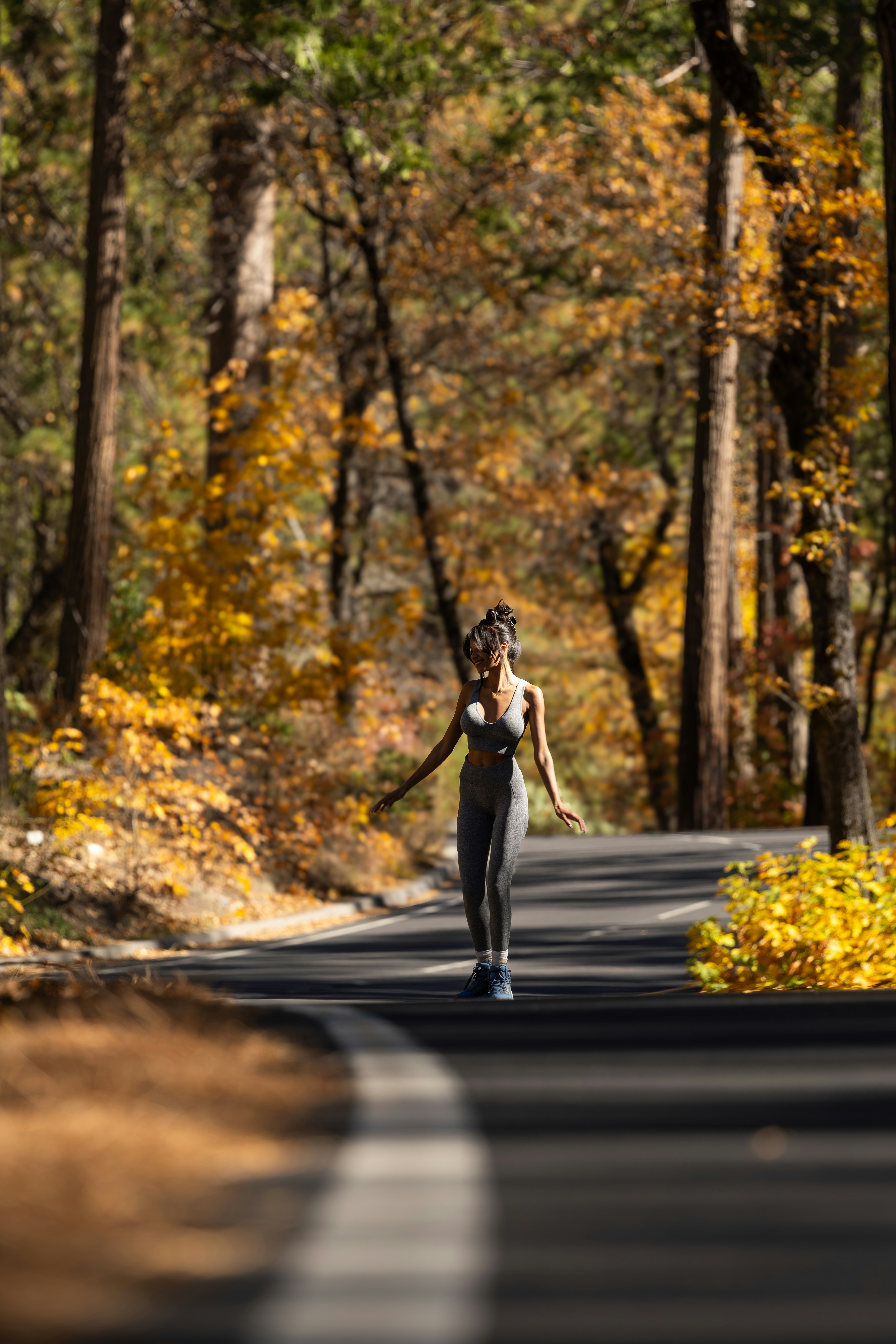 Solitary Runner on a Winding Forest Road in Autumn Light