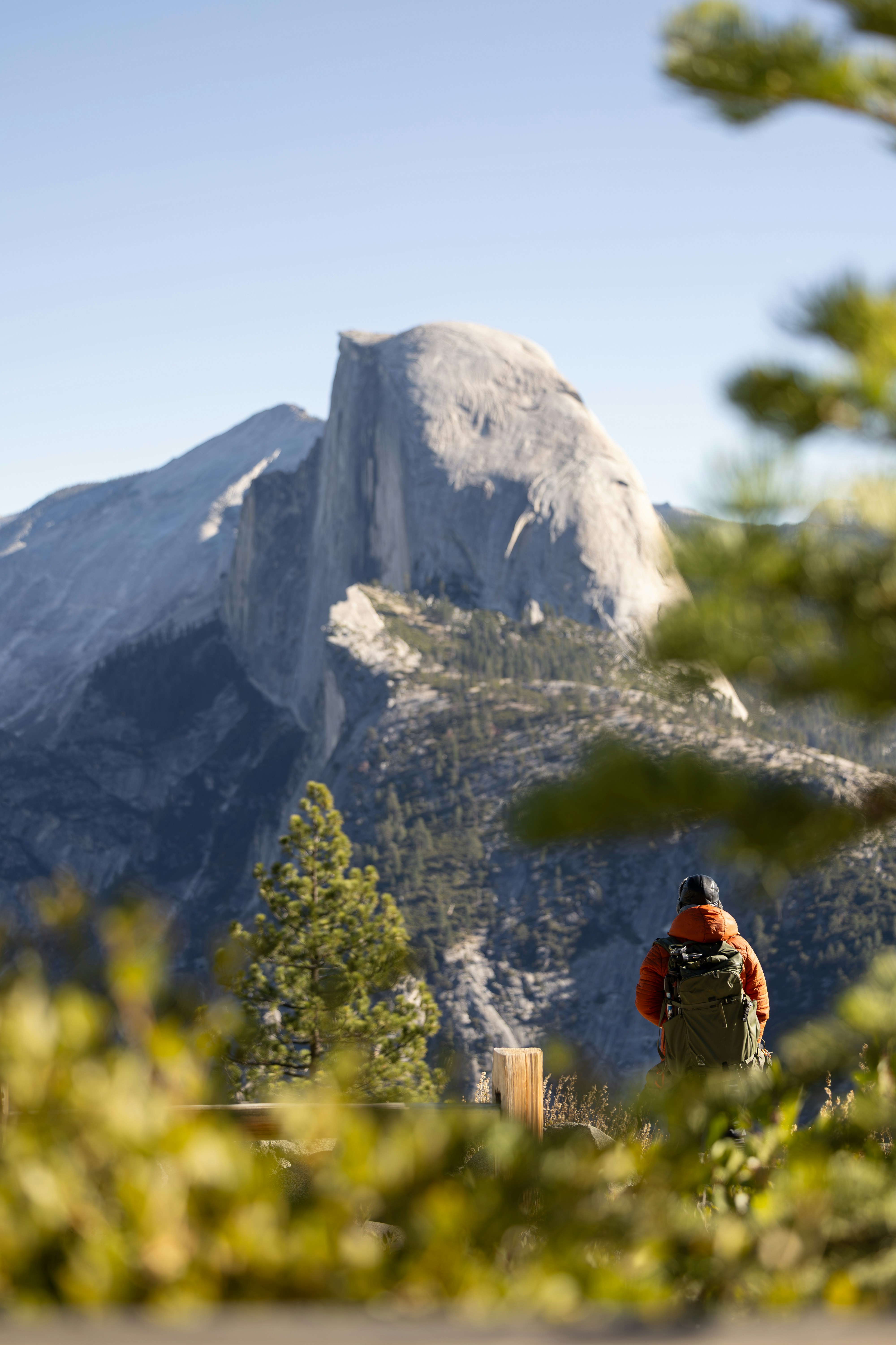 Granite Sentinel and the Hiker Under a Clear Alpine Sky