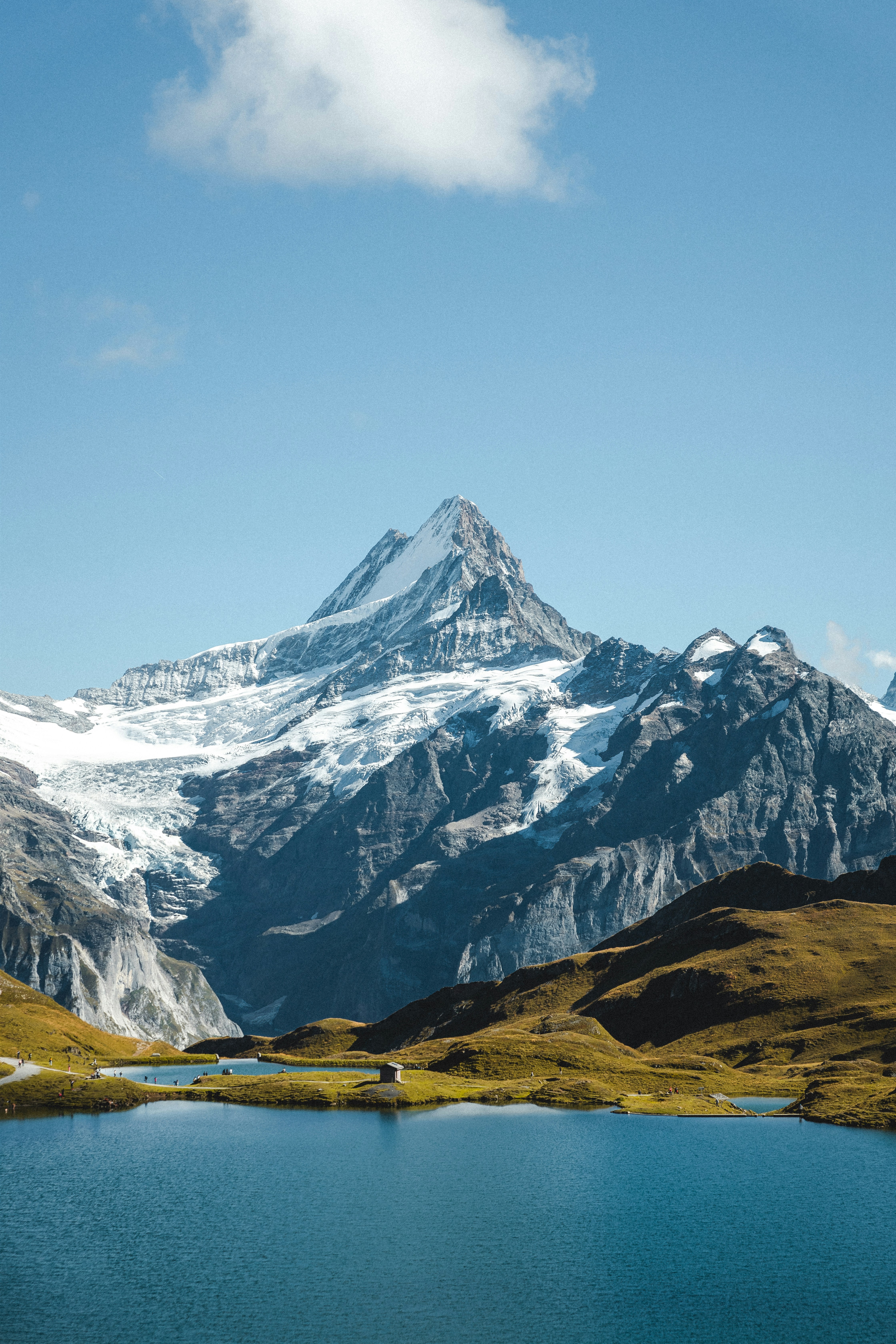 Snow-capped mountain range overlooking a blue lake photo – Free Travel ...