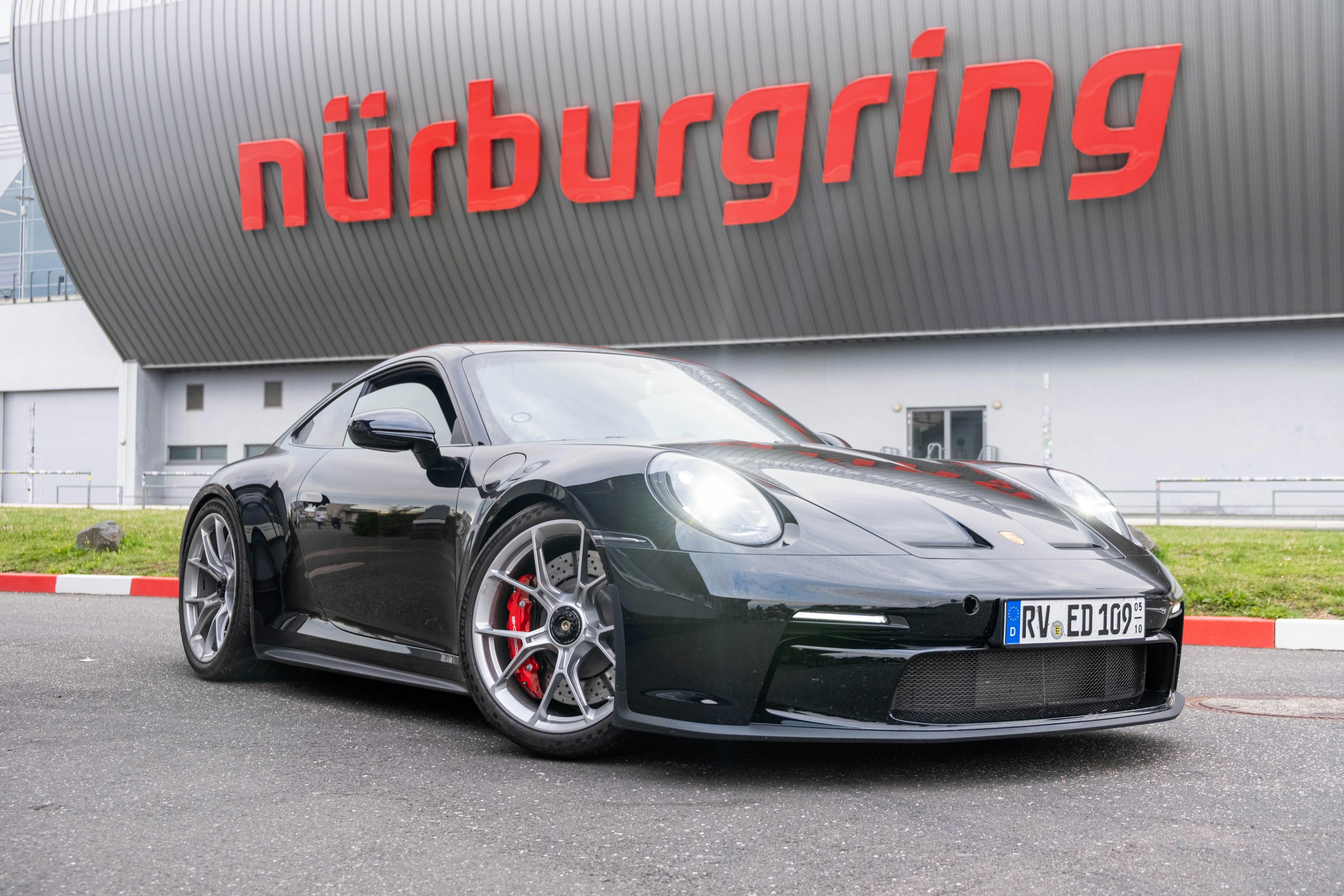 Noir Porsche at Nürburgring: A Low Stance by the Sign