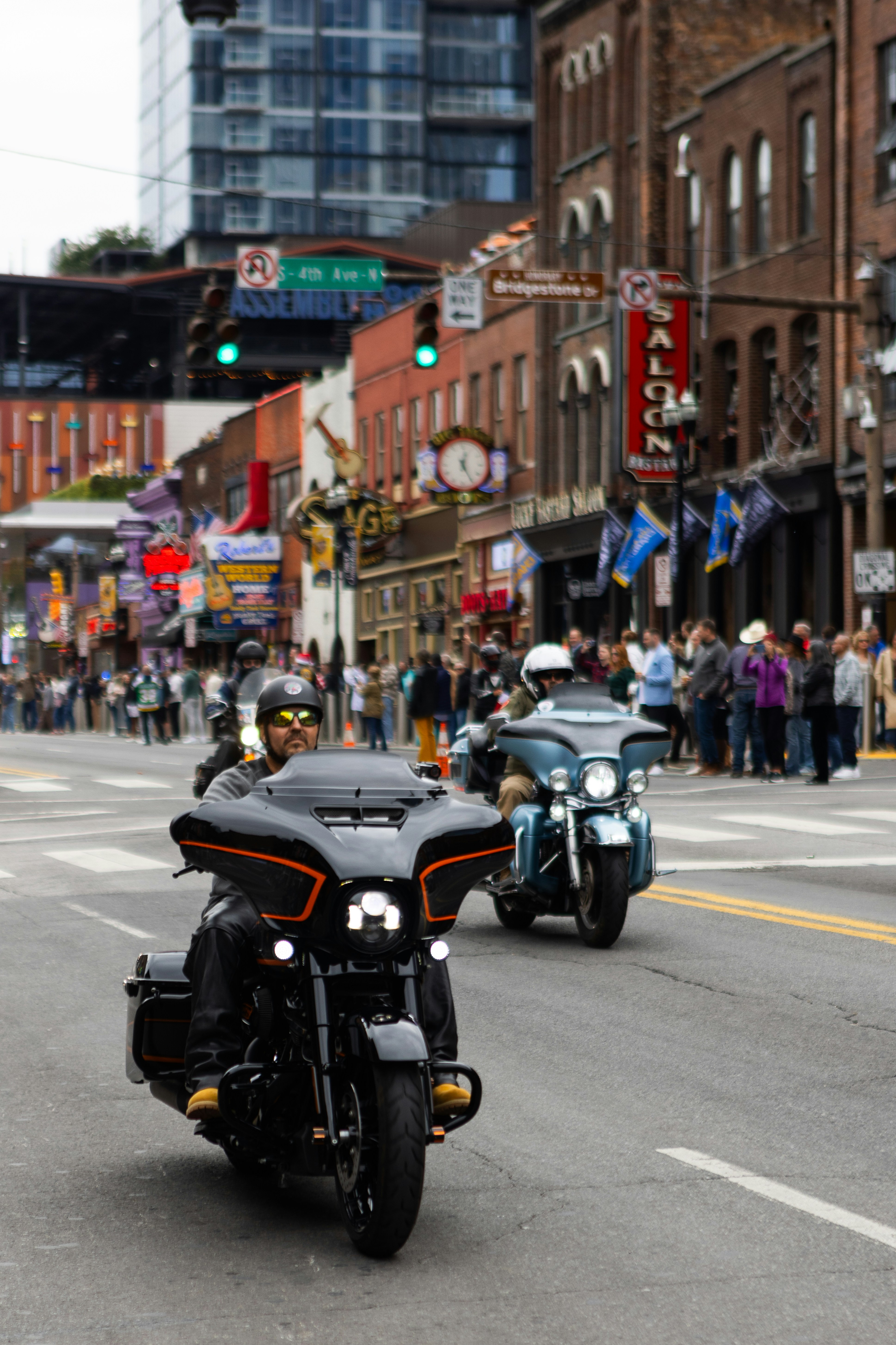 Downtown Parade of Chrome: Lead Rider Carves Through a Crowded Brick Street