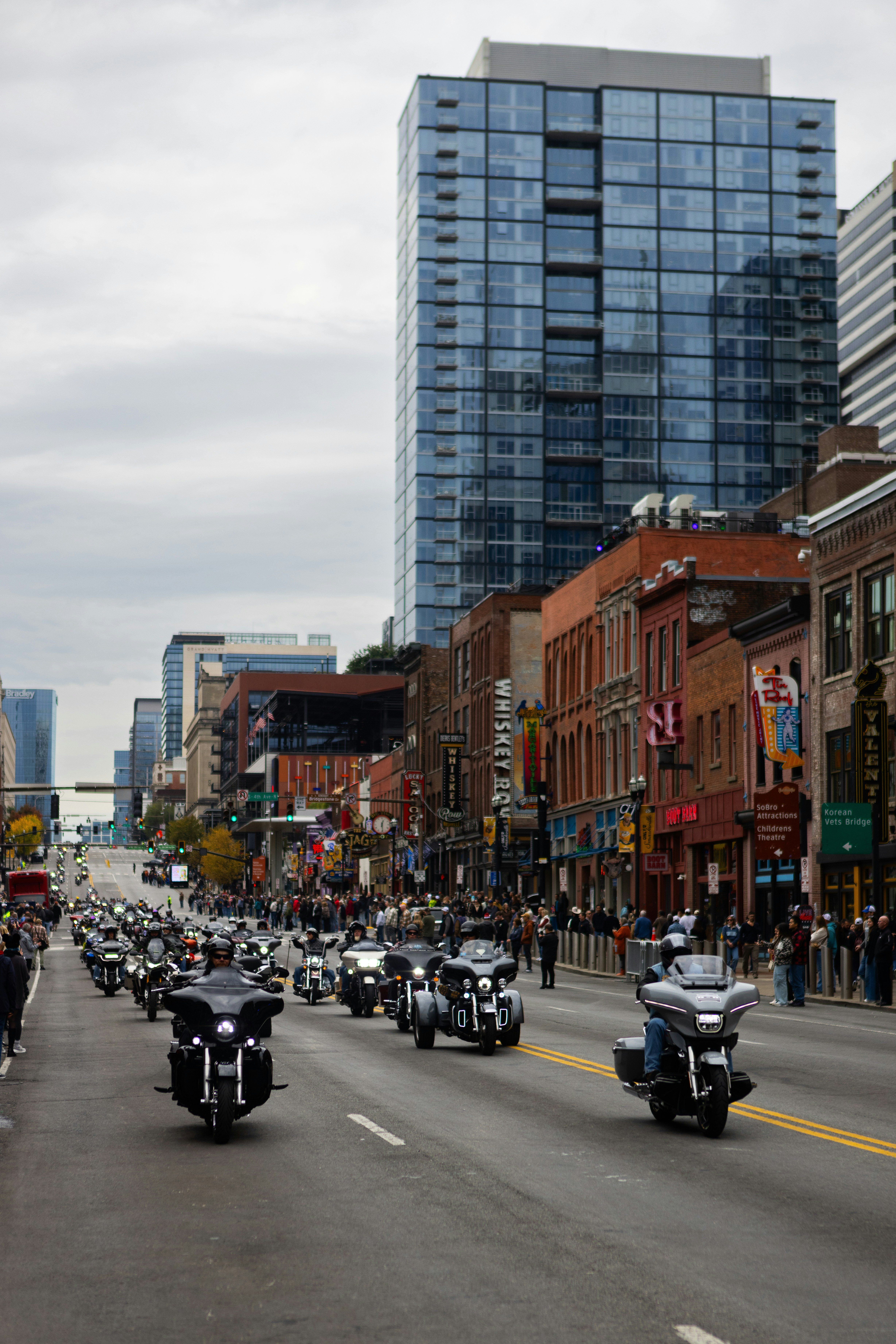 Chrome Motorcade Through a Brick-and-Glass Downtown