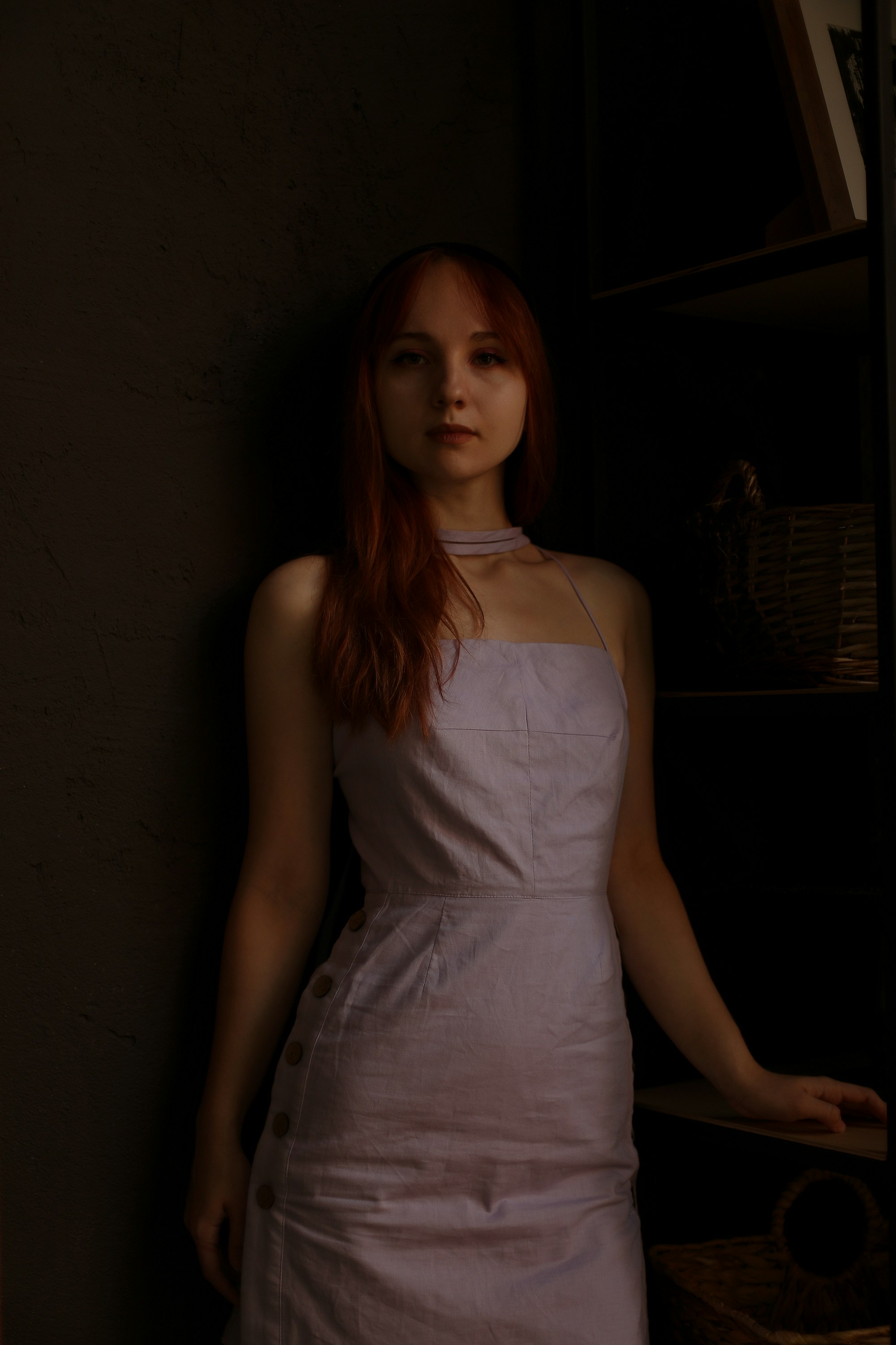 Amber Quiet: Portrait of a Red-Haired Woman in Dim Indoor Light