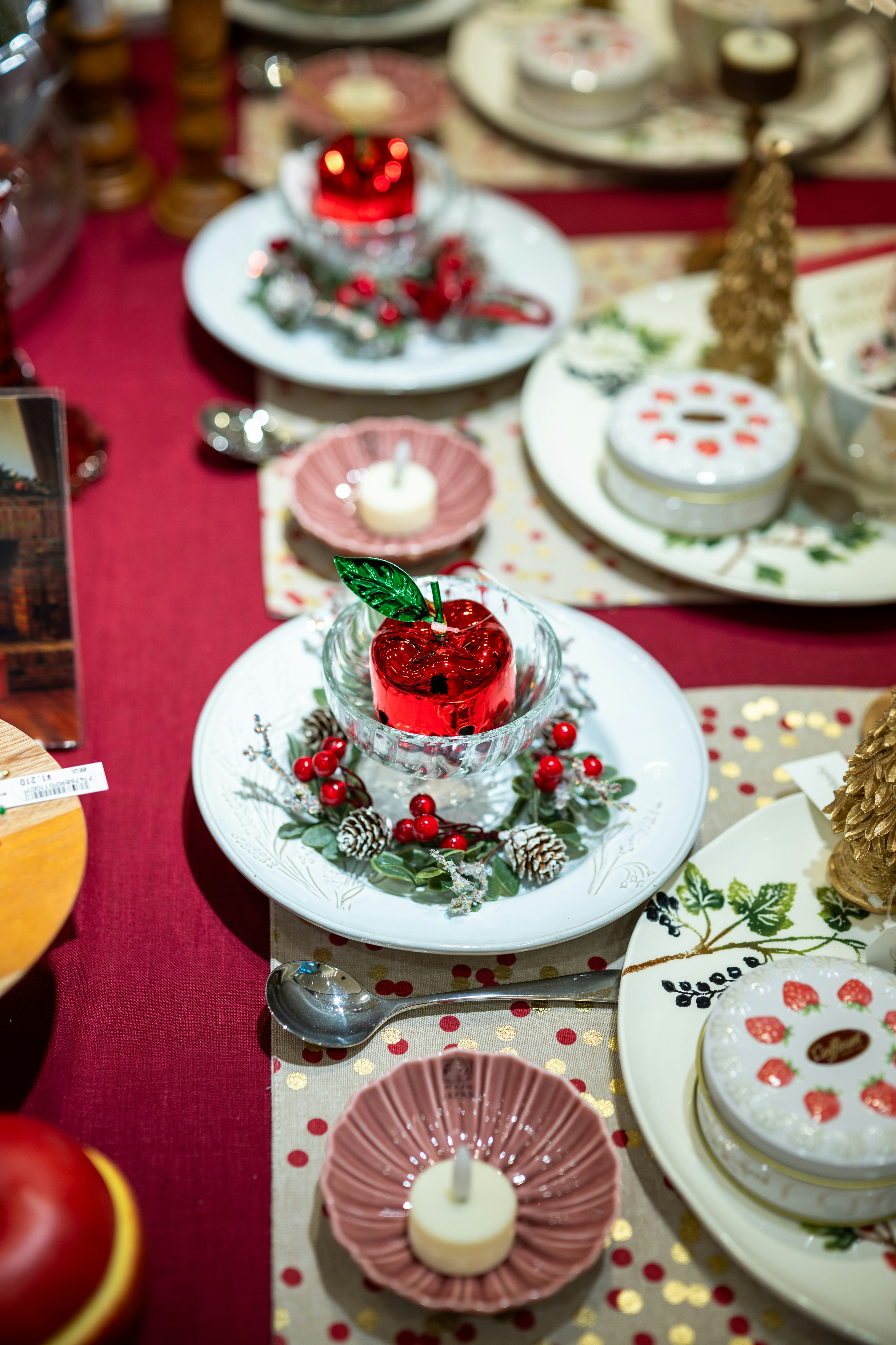 Crimson Crystal Apple centerpiece amid holly and pine