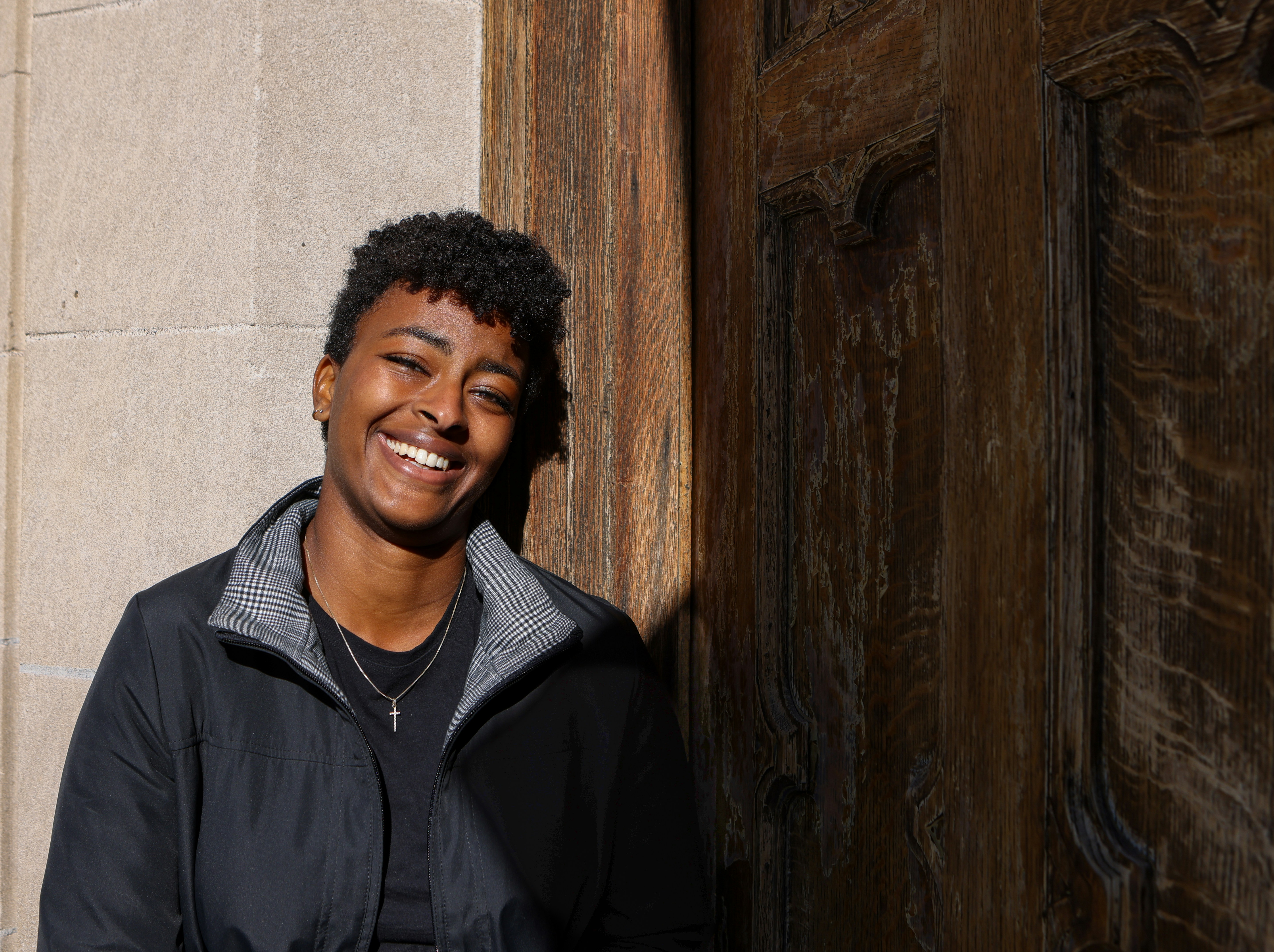 Warm Threshold Portrait: A Smile by the Weathered Door
