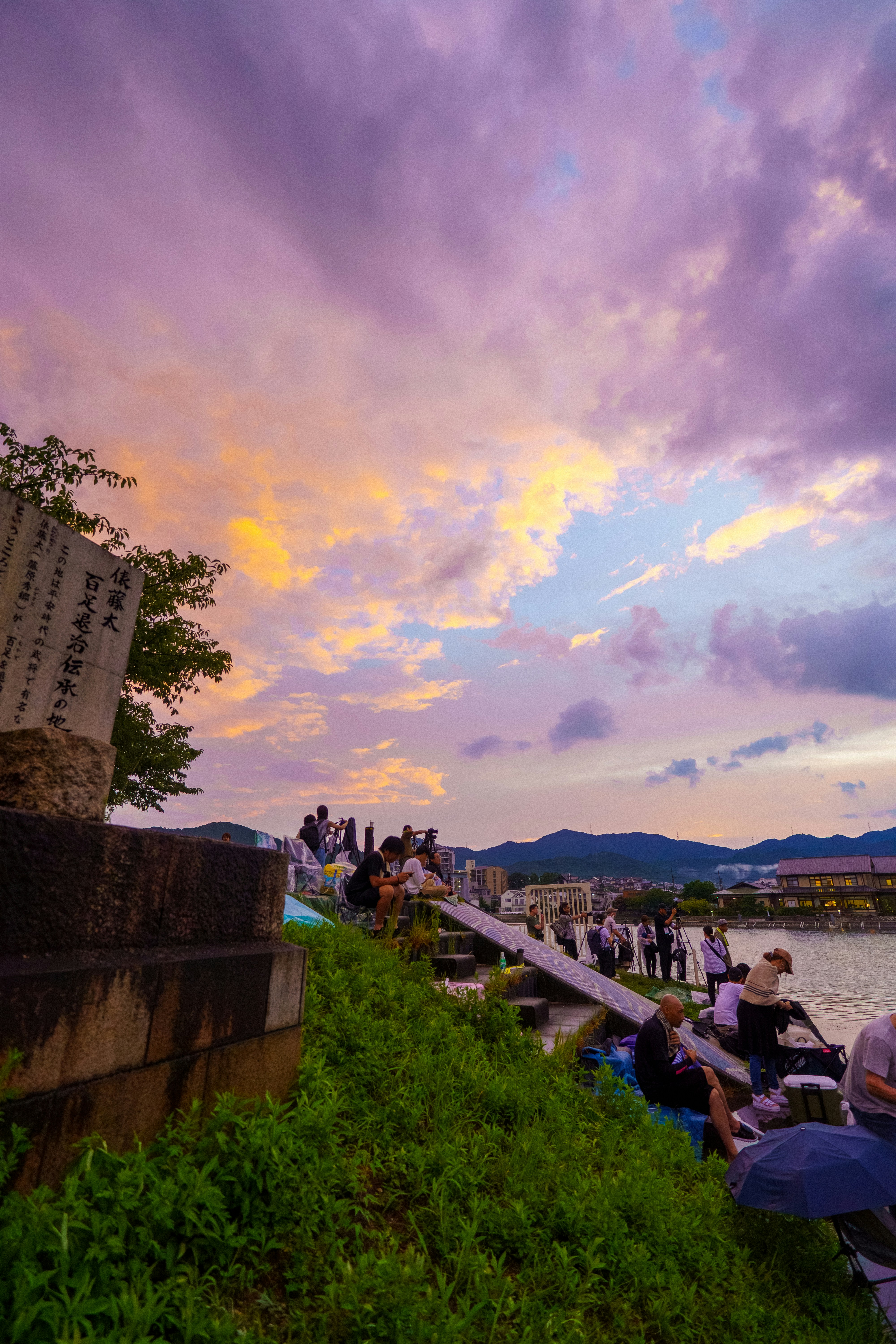 Amber Skies Over a Riverside Gathering