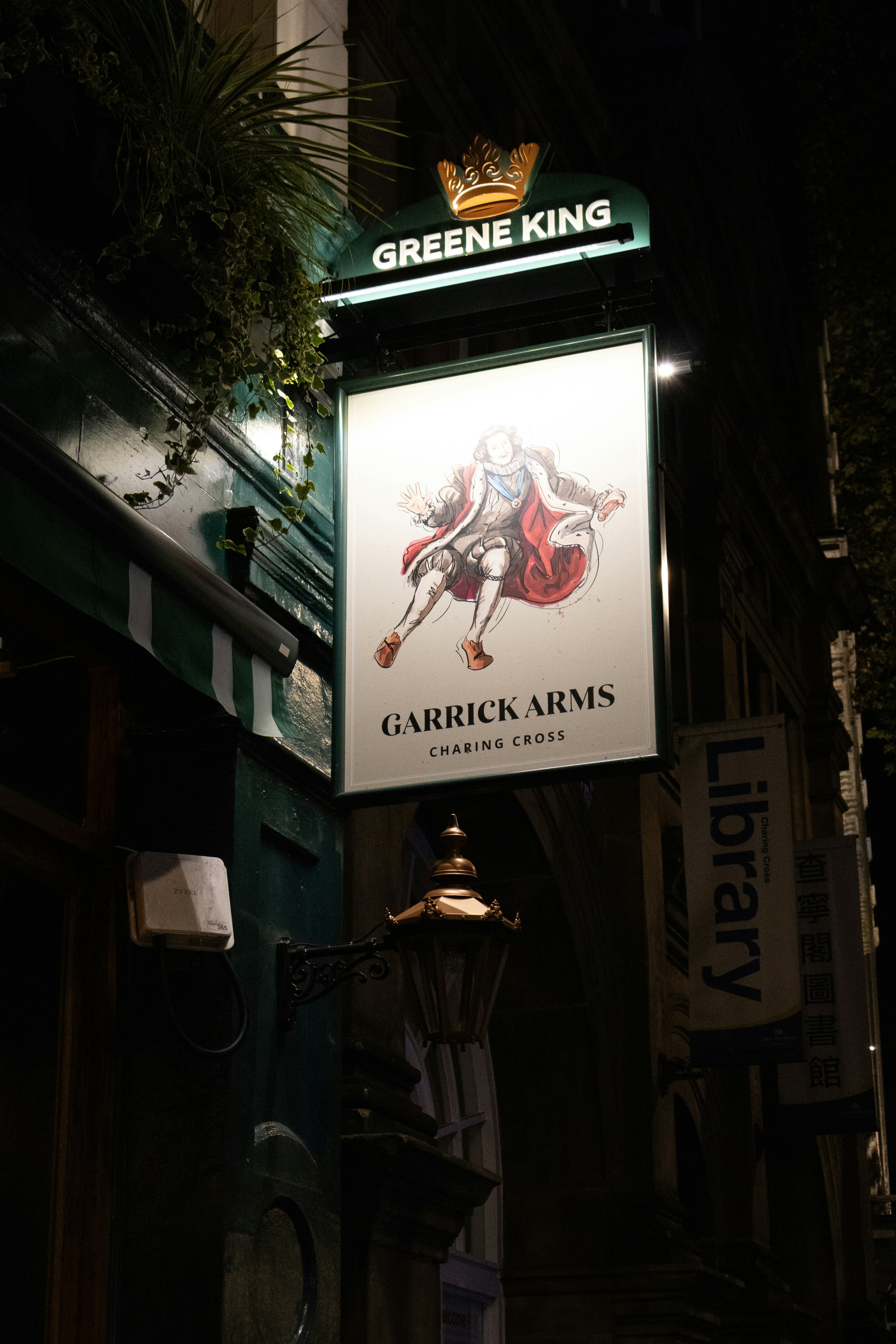 Garrick Arms Under the Greene King Crown: Lantern Glow on a Shadowed Façade