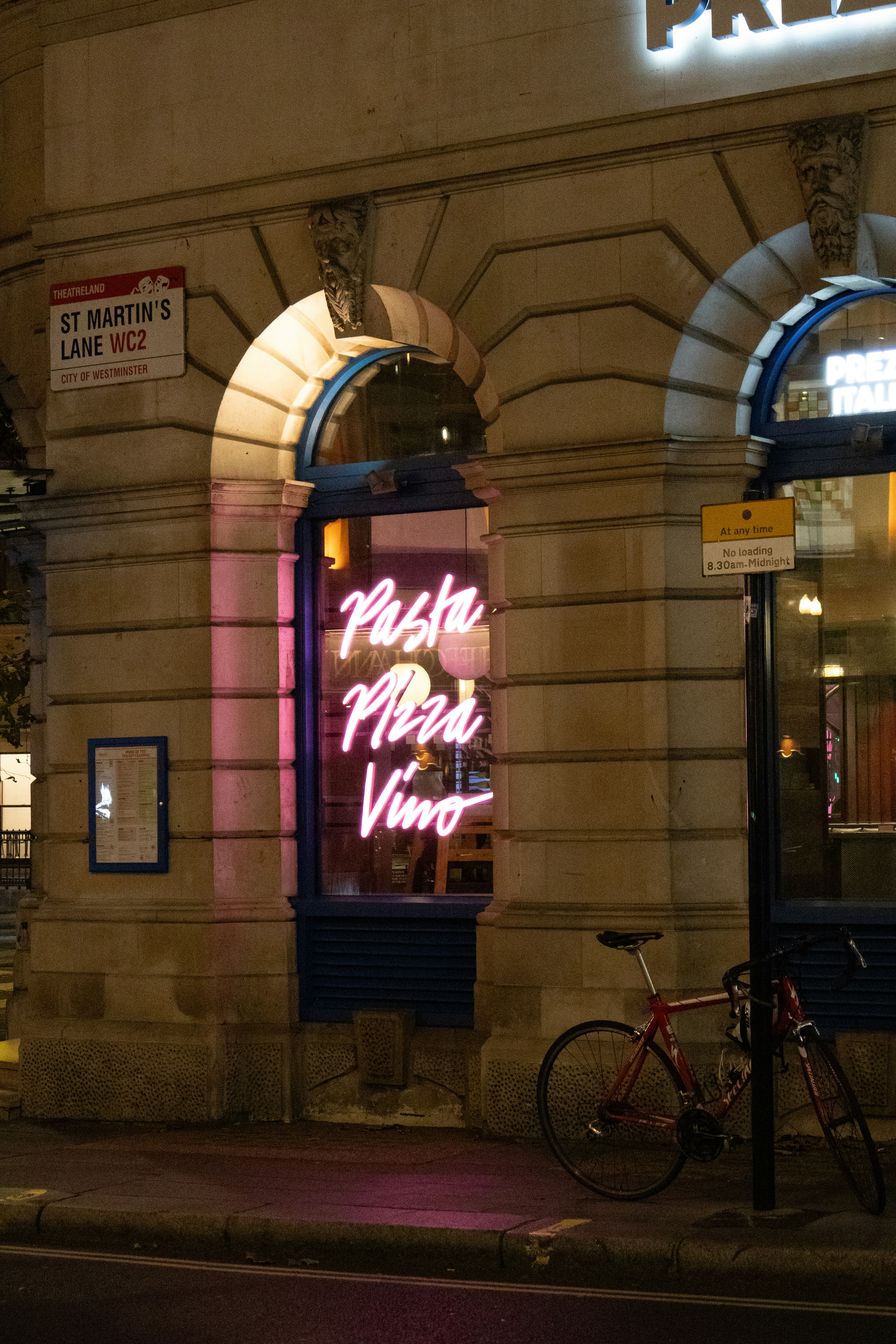 Neon Pizza in a Stone Arch: Nightfall on St. Martin's Lane