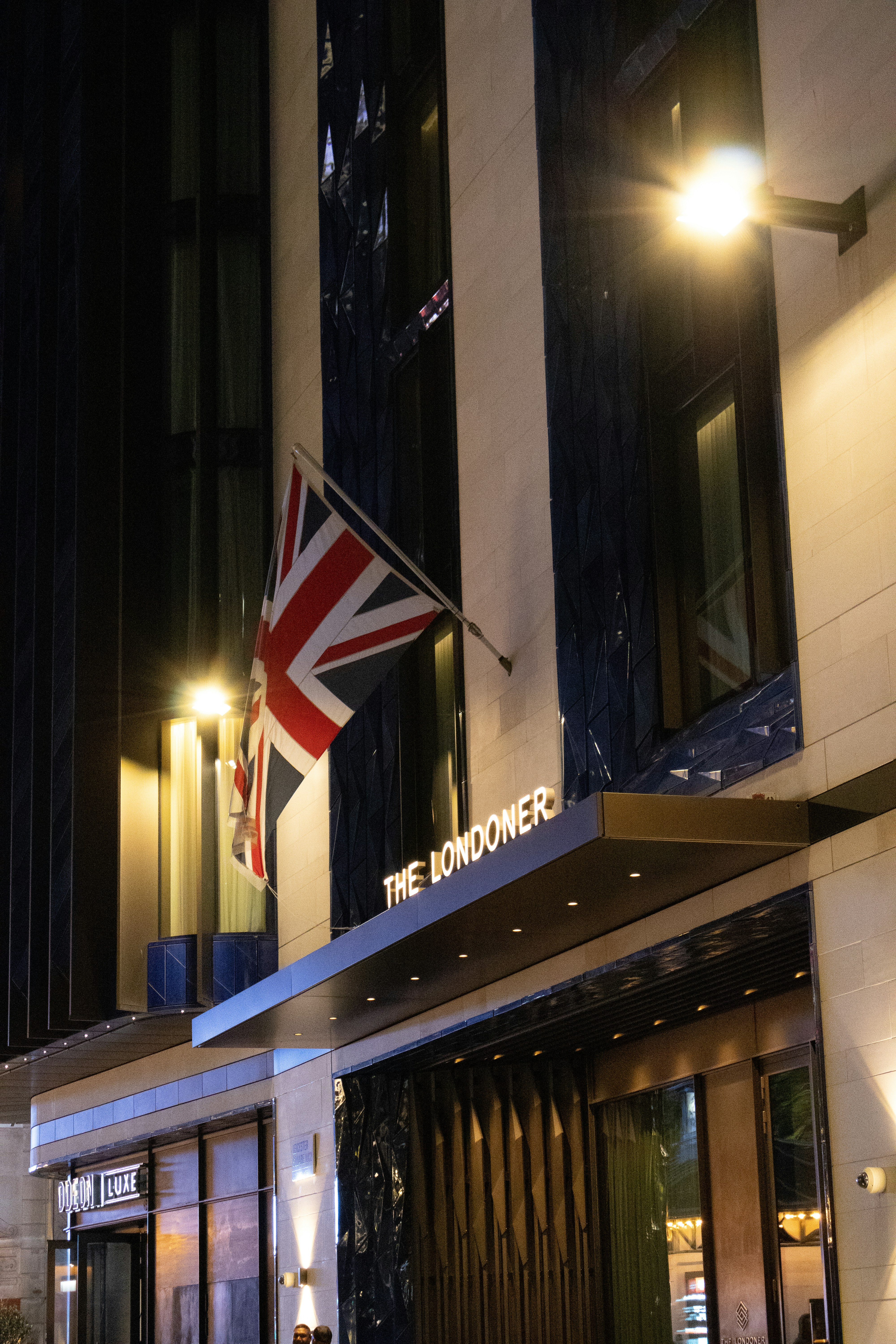 Night Facade of The Londoner: Union Jack in Neon Glow