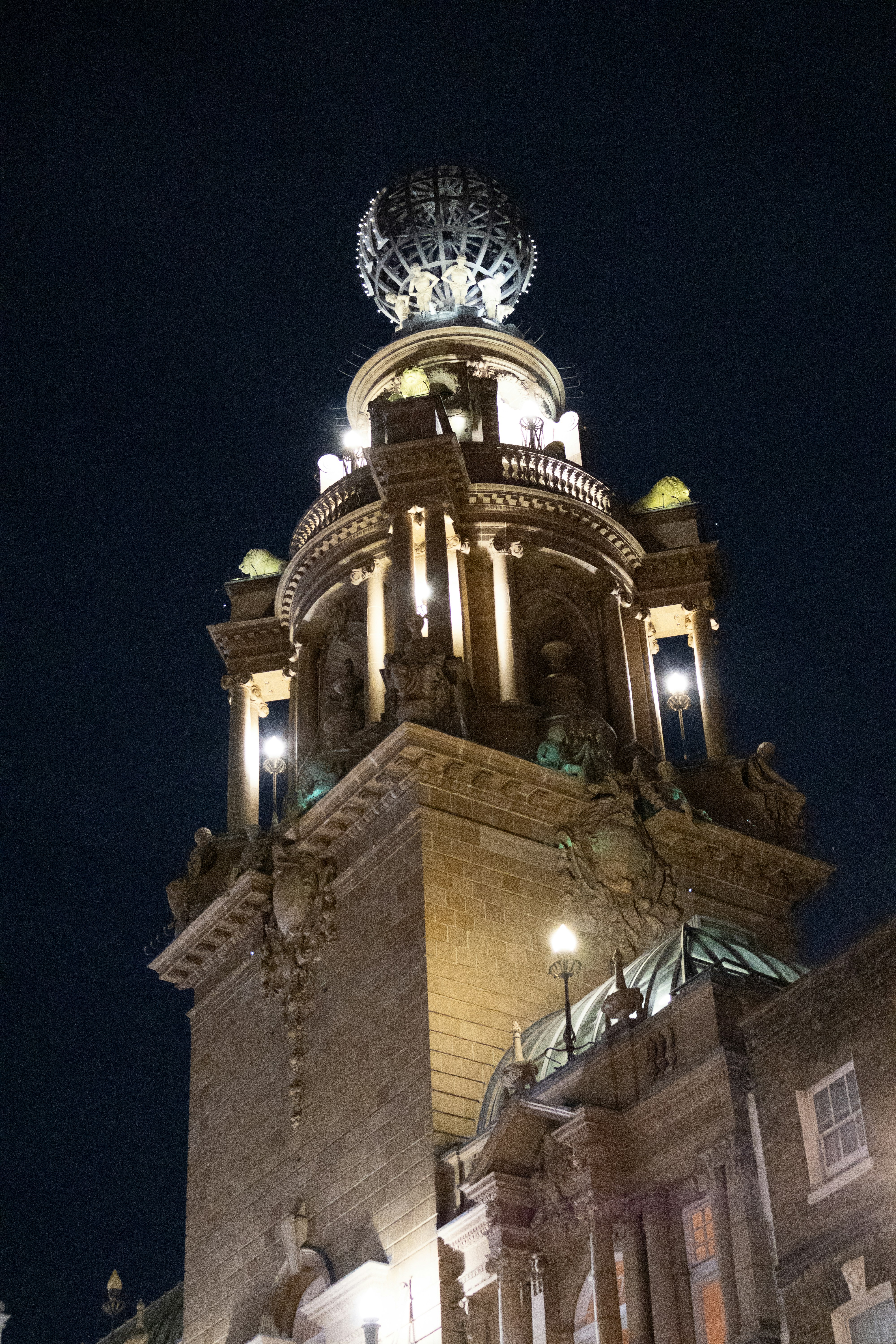 Crowned in Night: An Iron Lattice Orb Surmounting a Historic Tower