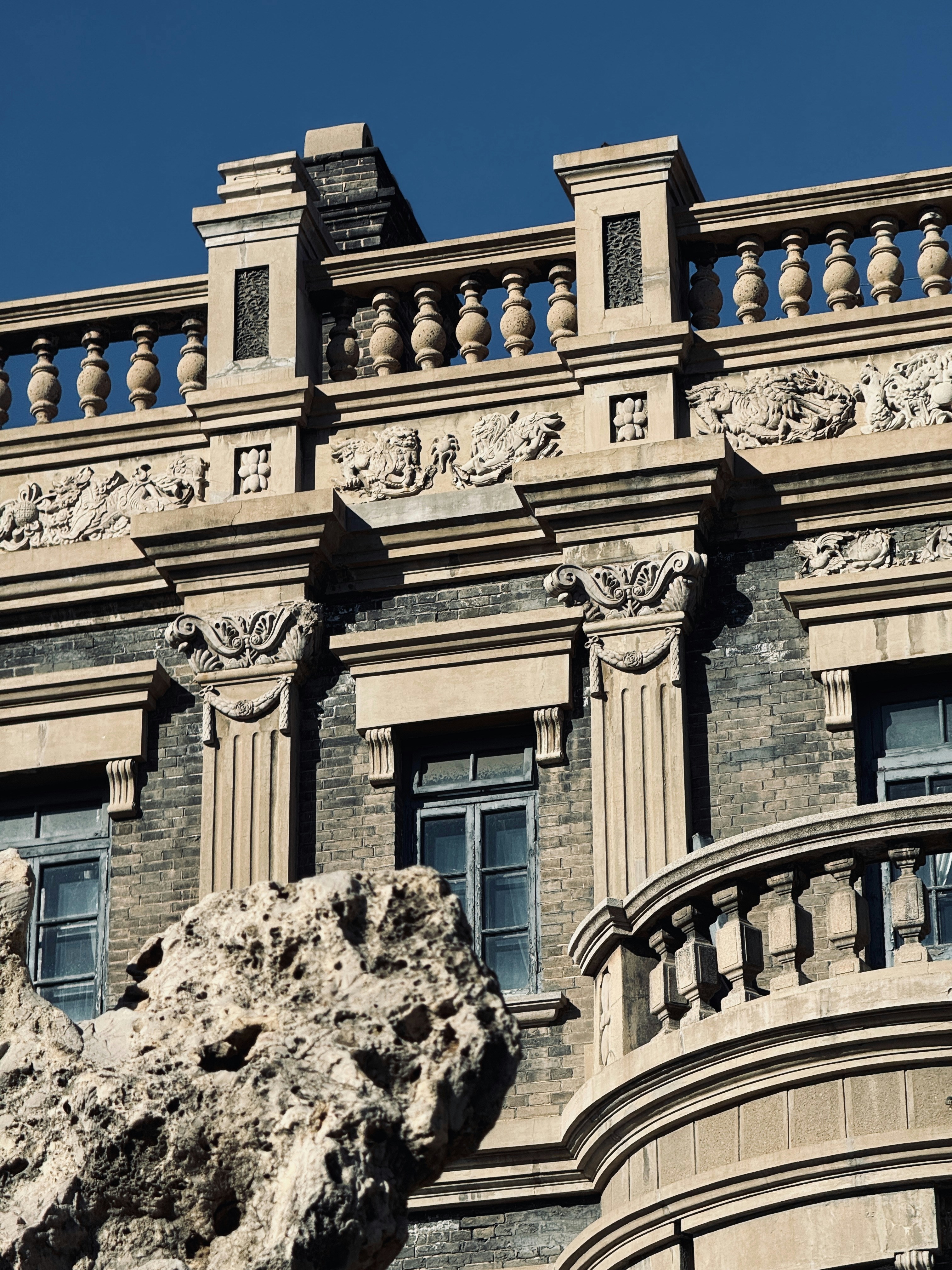 Ornate Classical Facade Rising Above a Weathered Stone