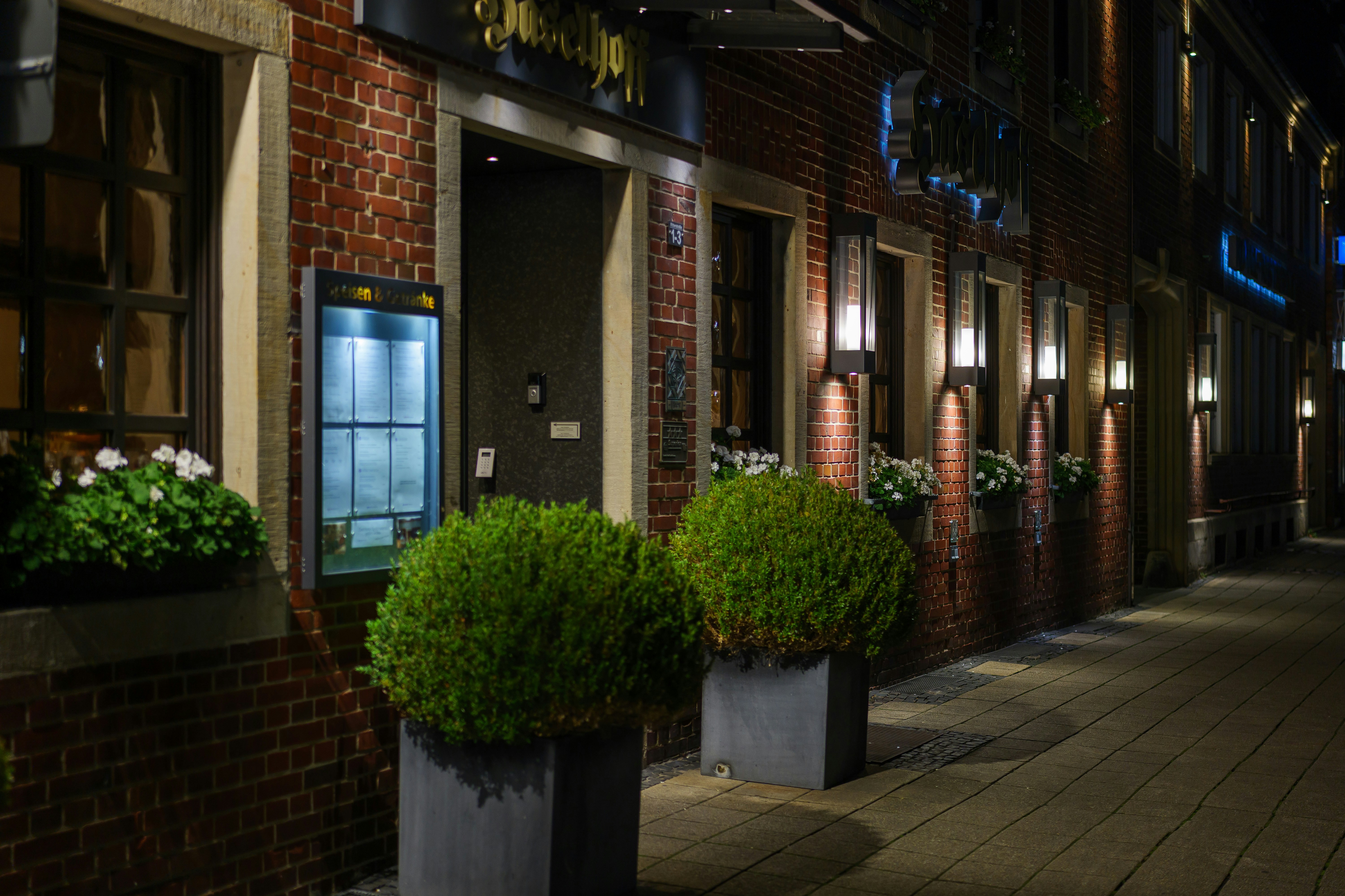Blue Window Glow on a Brick Street: Nighttime Quiet Alley