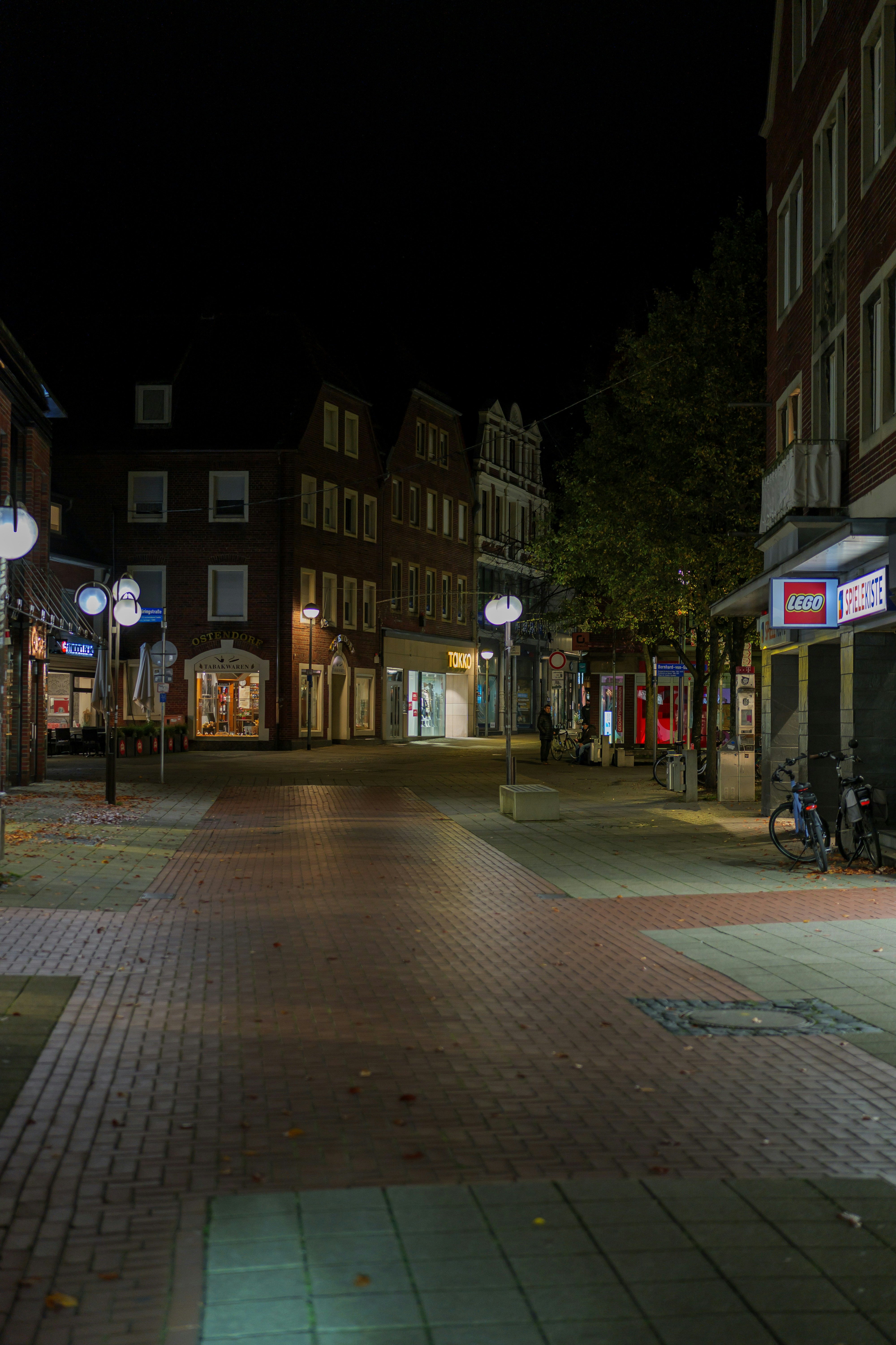 Midnight Promenade: Warm Storefronts Trace a Quiet City Street